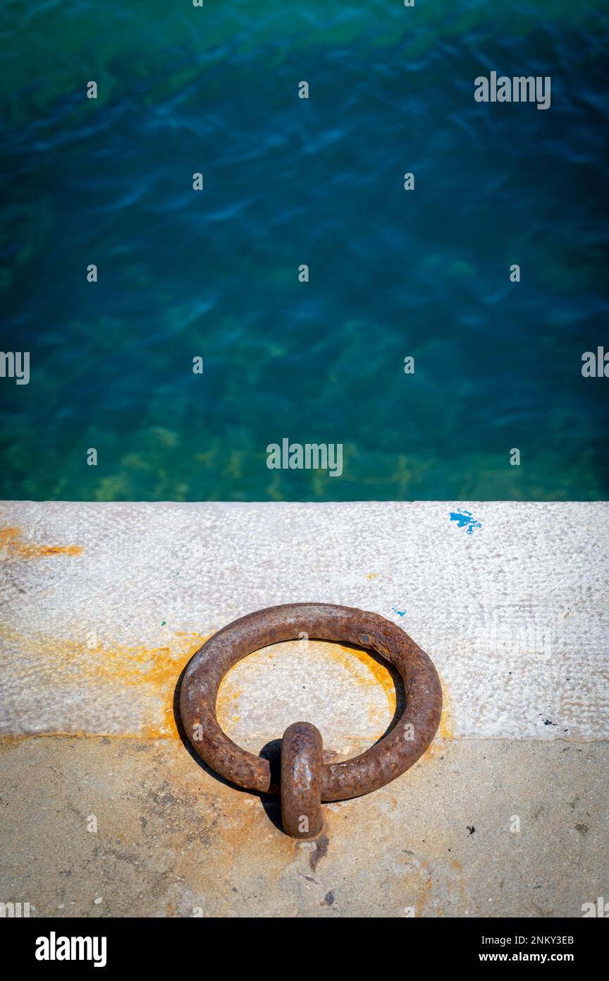 A metal mooring ring used for securing boats in the harbour at Lagos ...