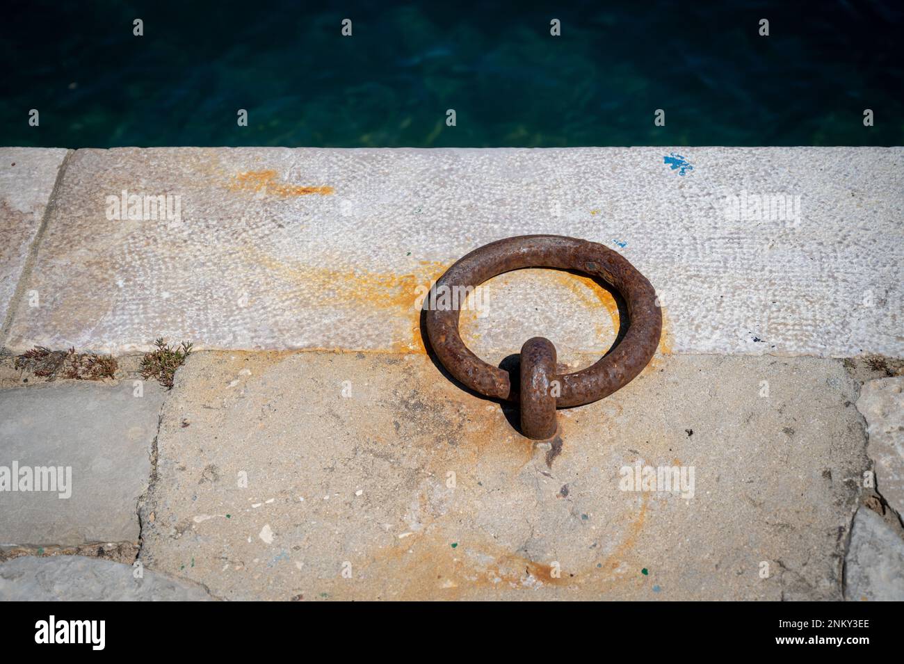 A metal mooring ring used for securing boats in the harbour at Lagos ...