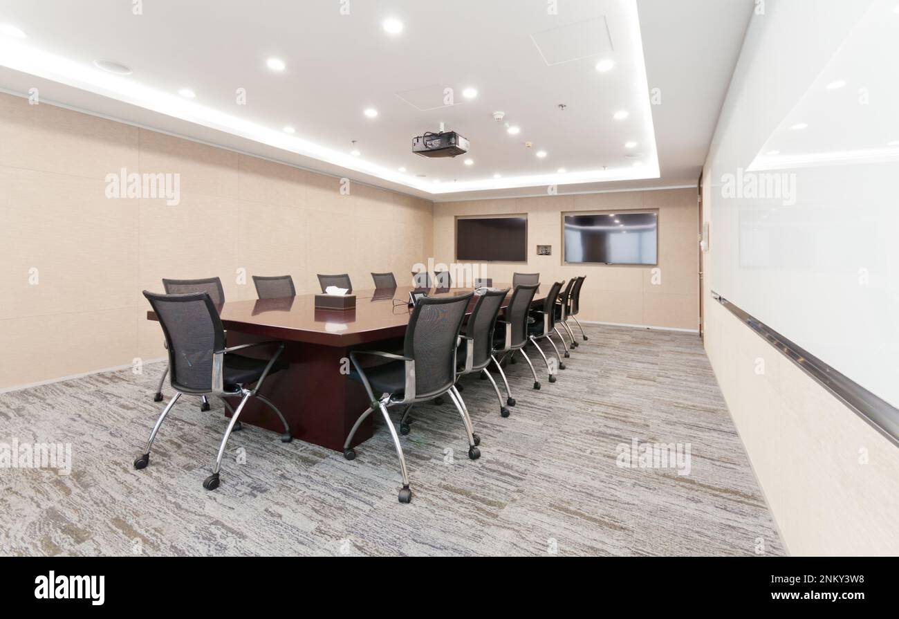 A modern conference room featuring a sleek flat-screen television ...