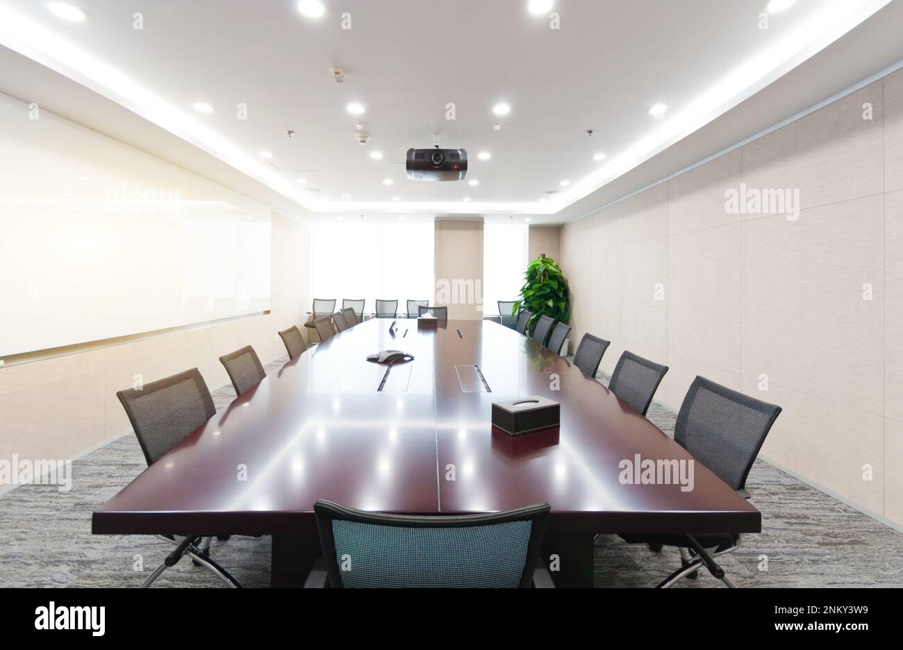 A conference table in a professional office setting, surrounded by ...