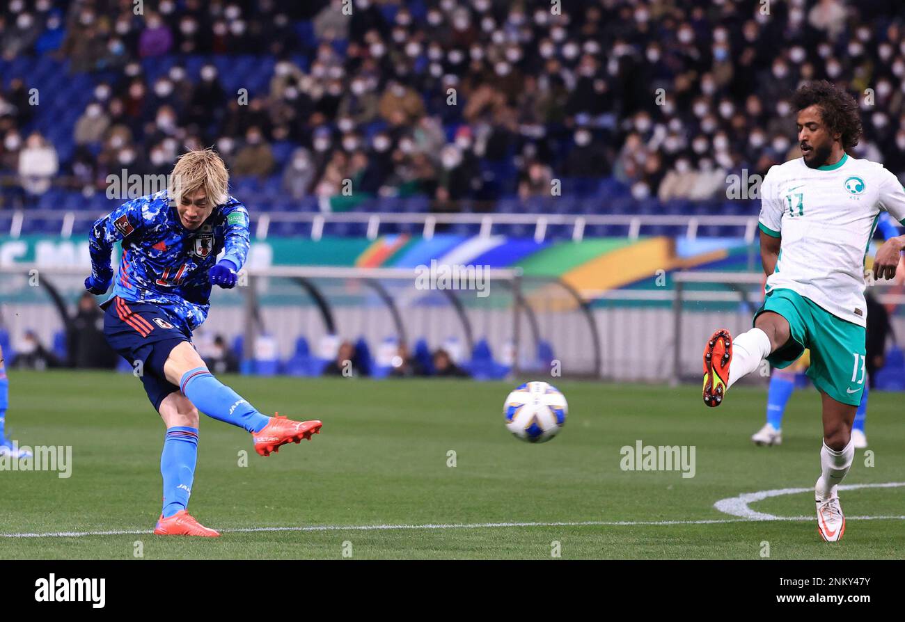 Japan's striker Junya Ito (L) scores a goal during the second half of ...