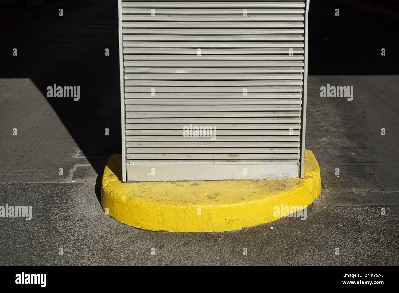 Metal post in a parking lot, grey asphalt background Stock Photo - Alamy
