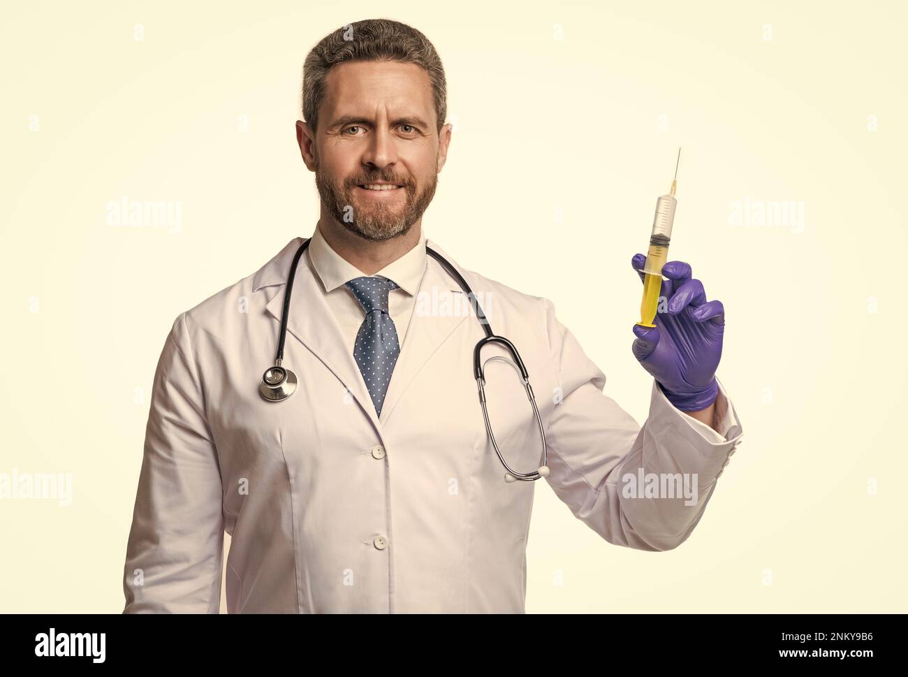 Happy doctor holding medical syringe. Surgeon prepared injection ...