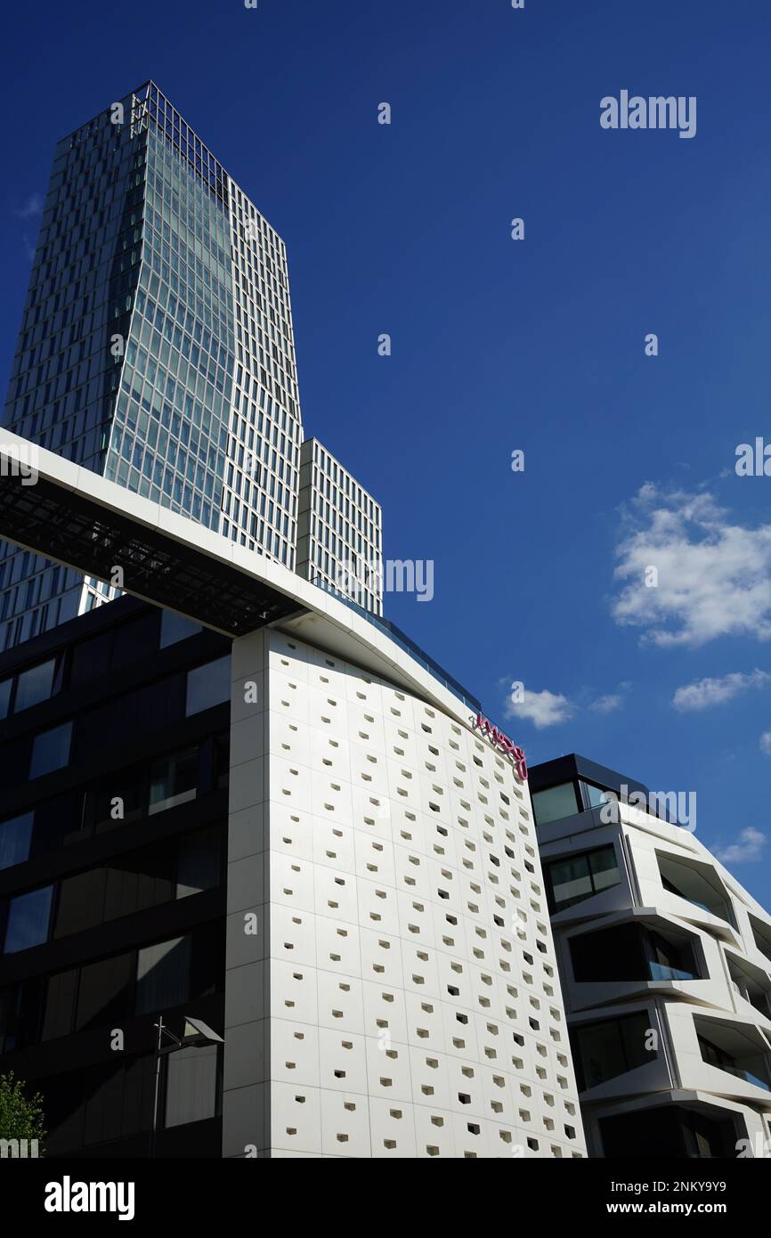 This image features two tall modern buildings against a backdrop of a ...