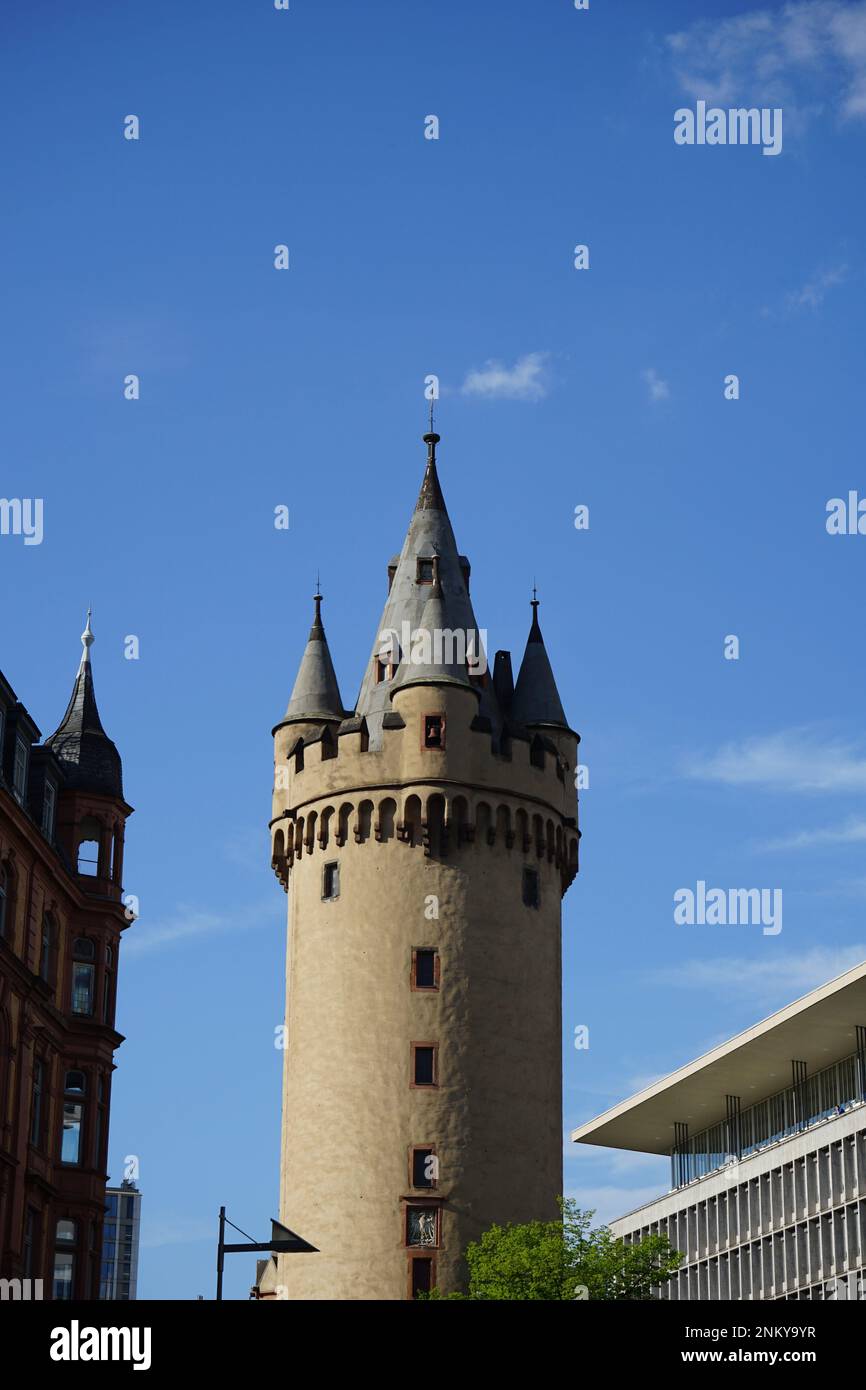 This stock photo features an old tower situated amongst more modern ...