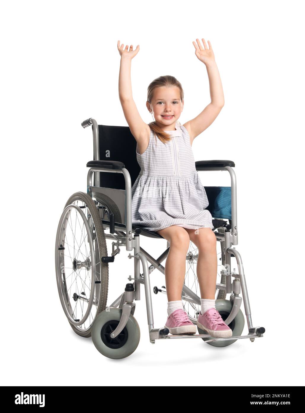 Little girl in wheelchair on white background Stock Photo - Alamy