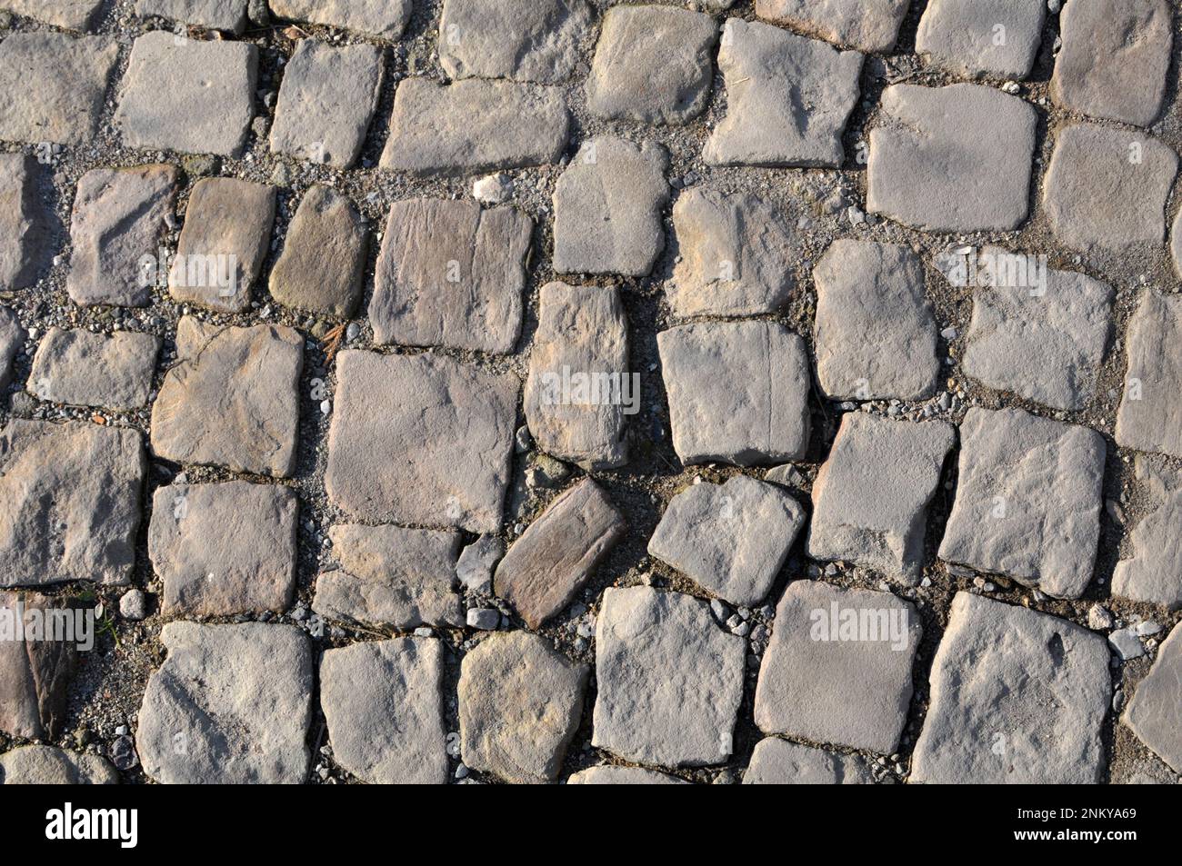 Old stone cobblestones from which the road is paved Stock Photo - Alamy