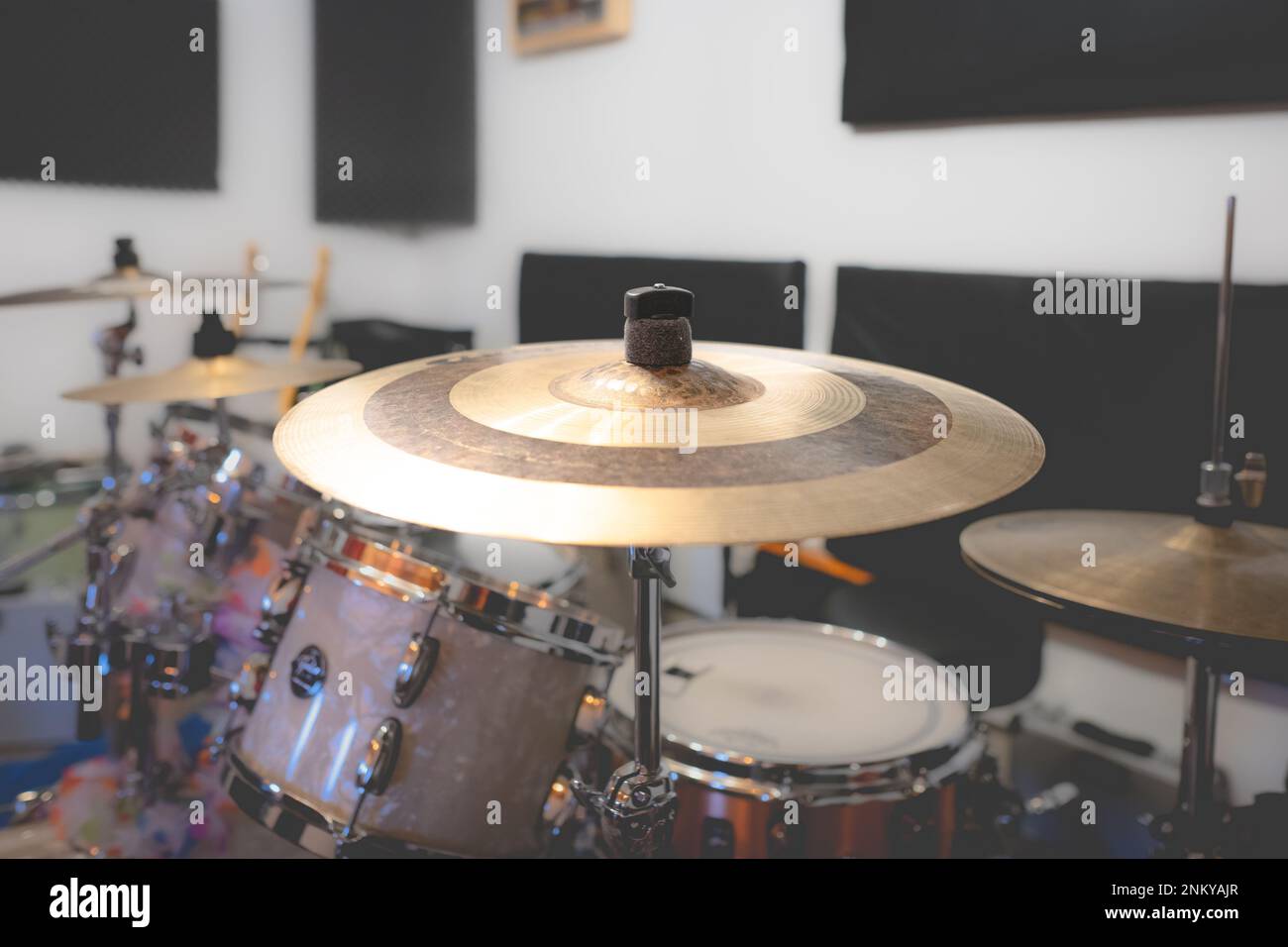 A professional recording studio featuring a full drum kit and modern ...