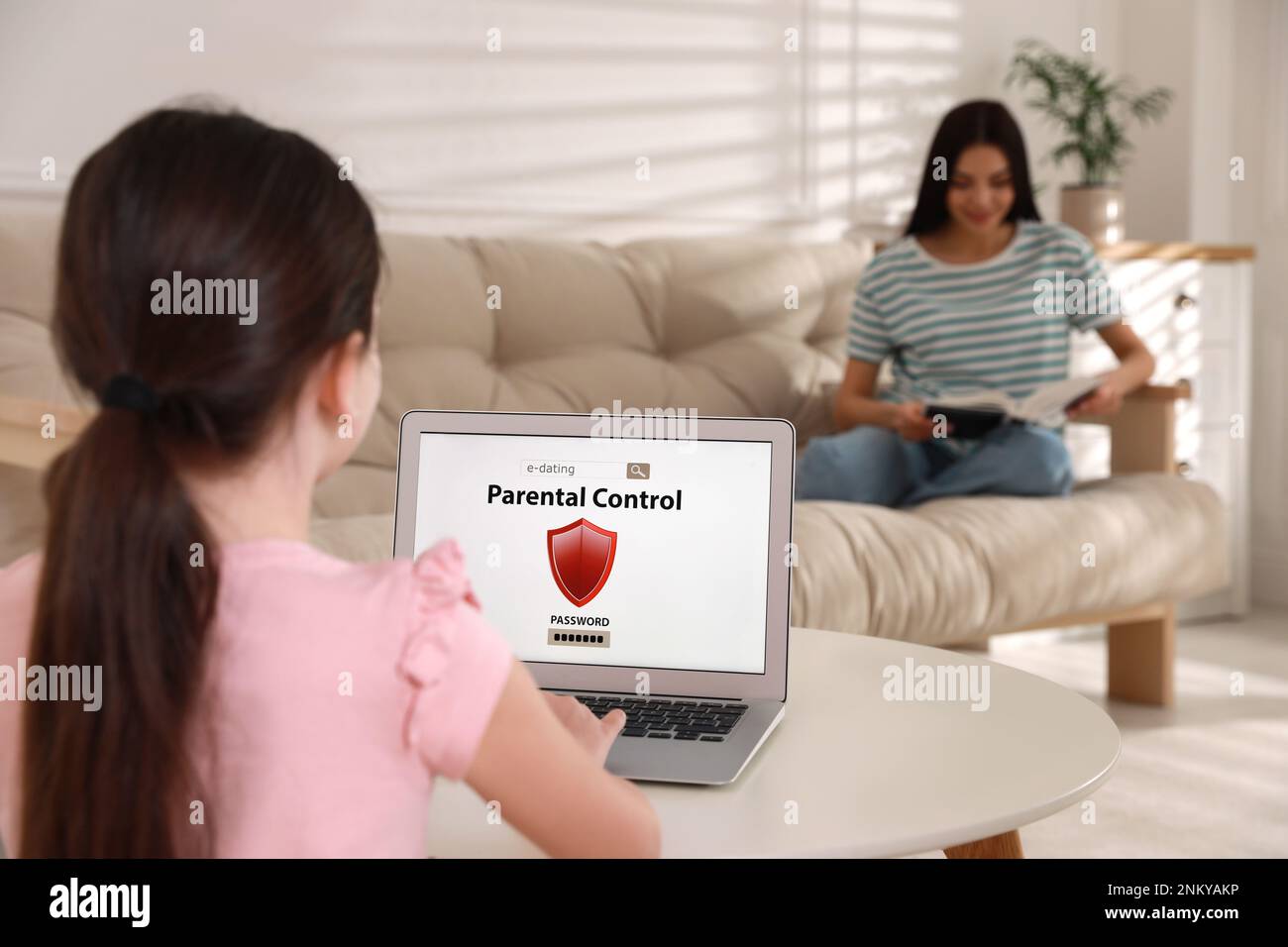 Little girl having access restriction by parental control on laptop at ...