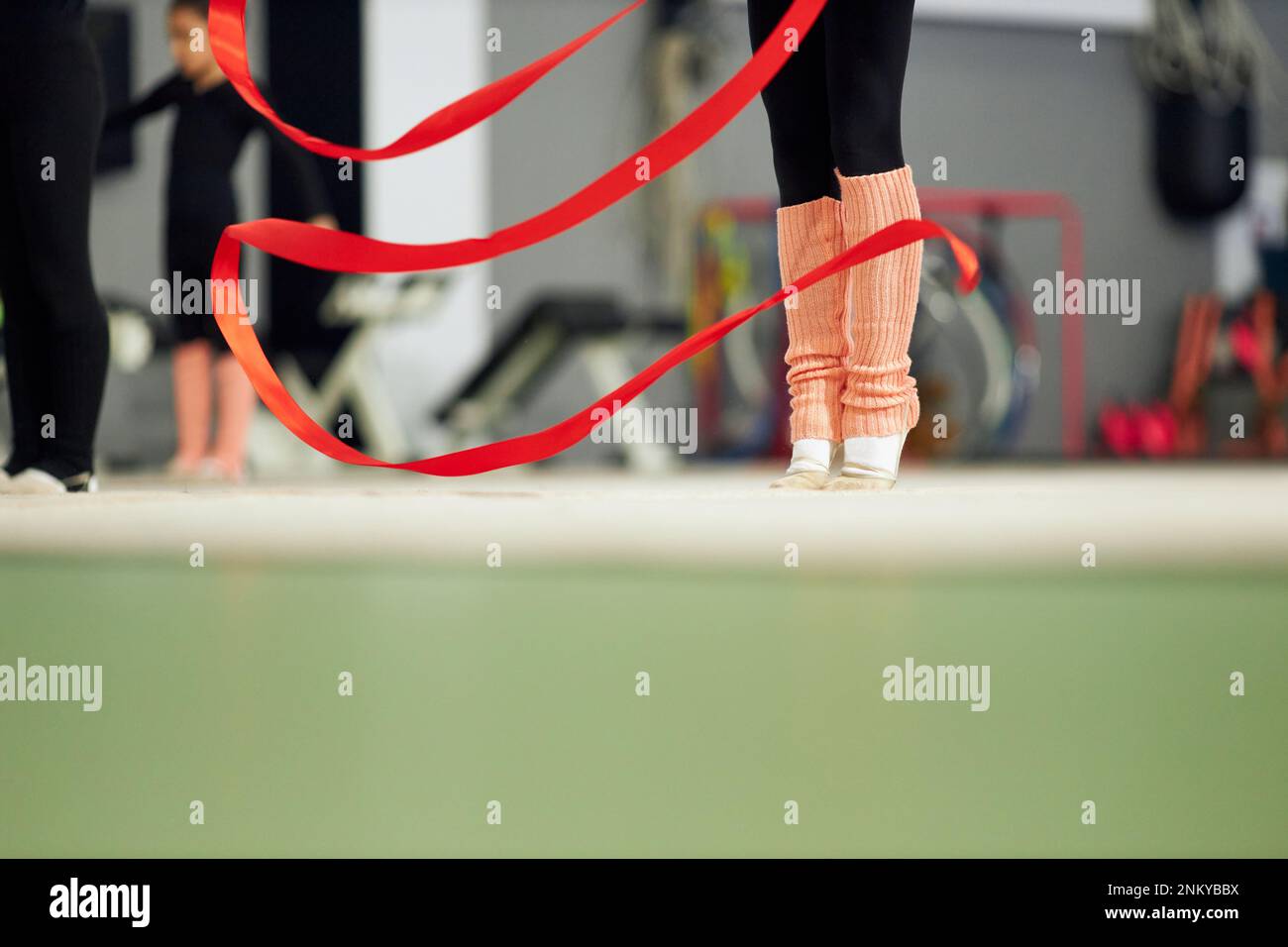 Cropped image of legs of little girl, child, rhythmic gymnast training ...