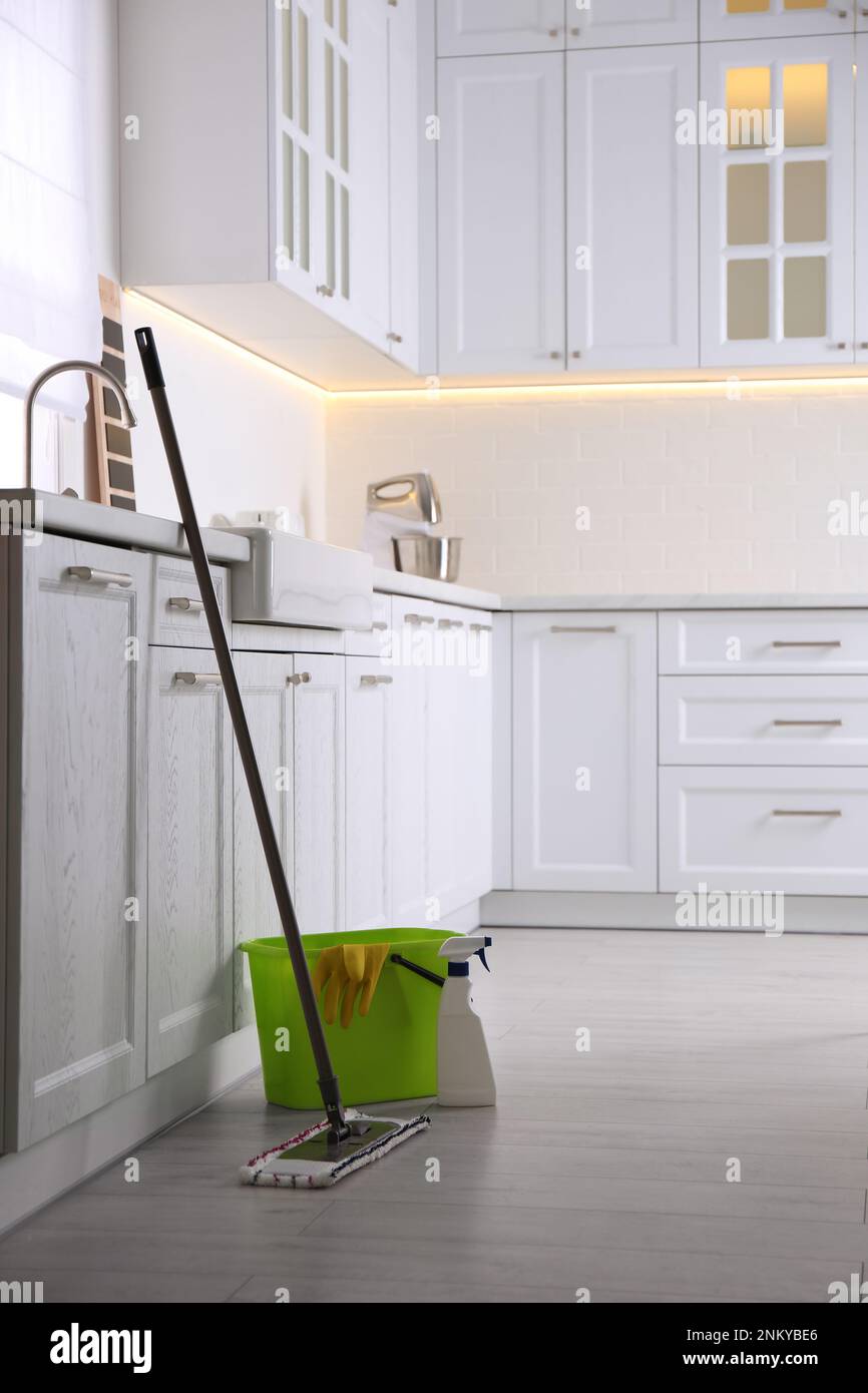 Floor mop, bucket and cleaning products in kitchen Stock Photo - Alamy
