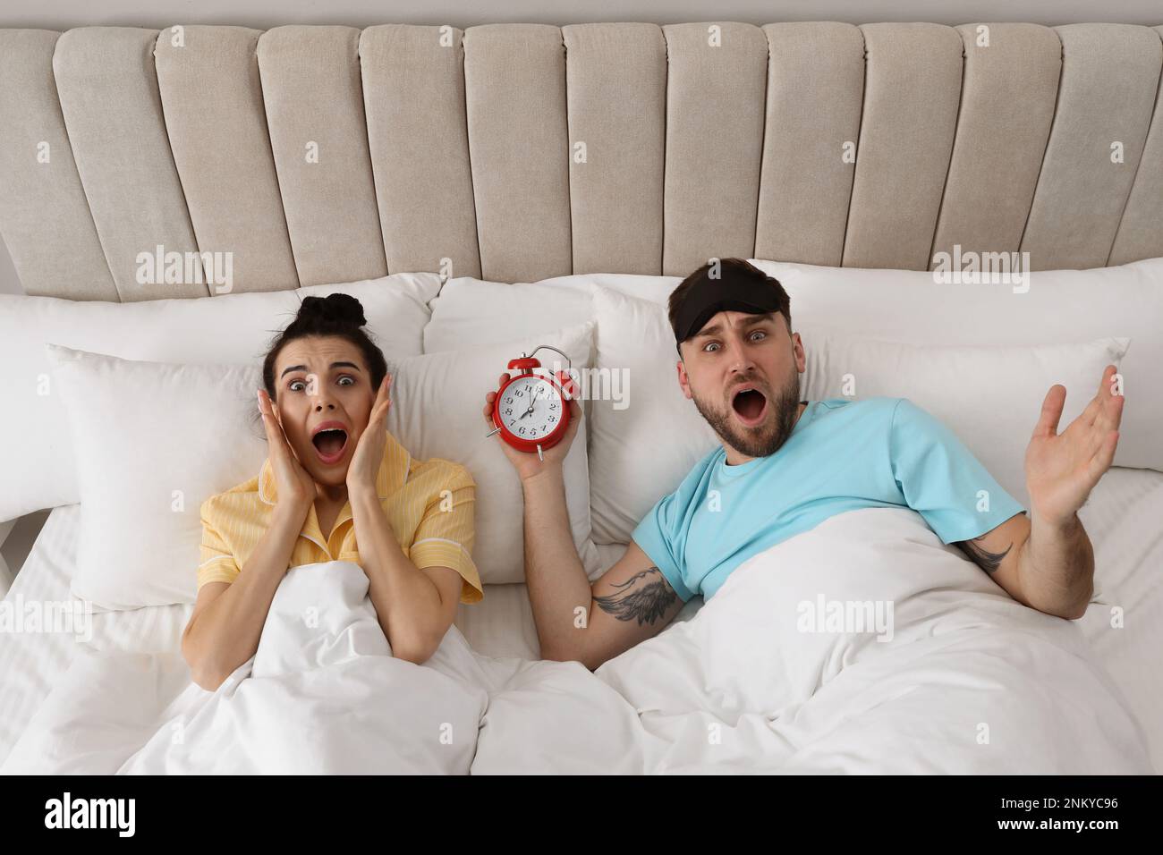Emotional overslept couple in bed, above view. Being late concept Stock ...