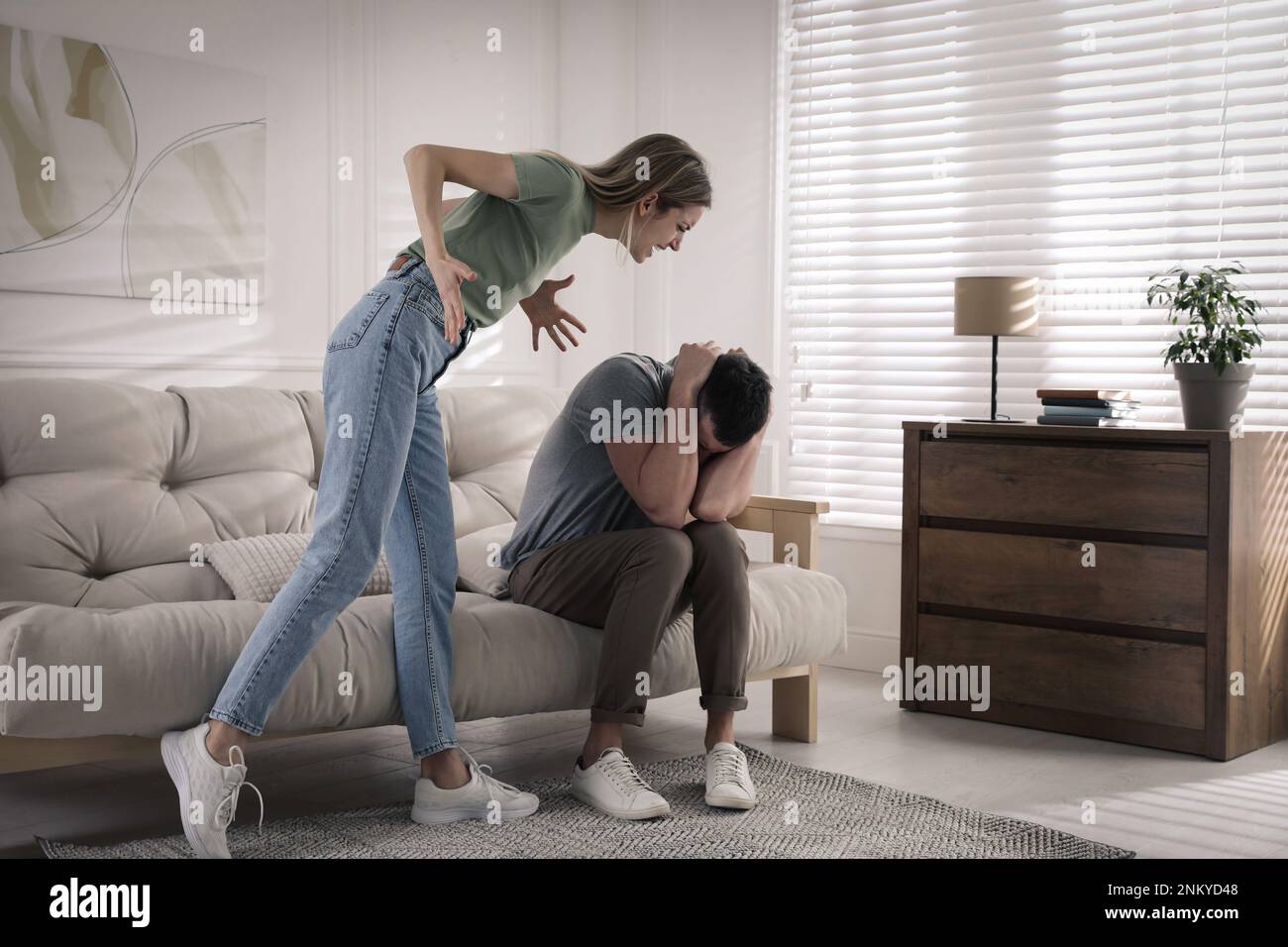 Woman abusing man at home. Domestic violence Stock Photo - Alamy