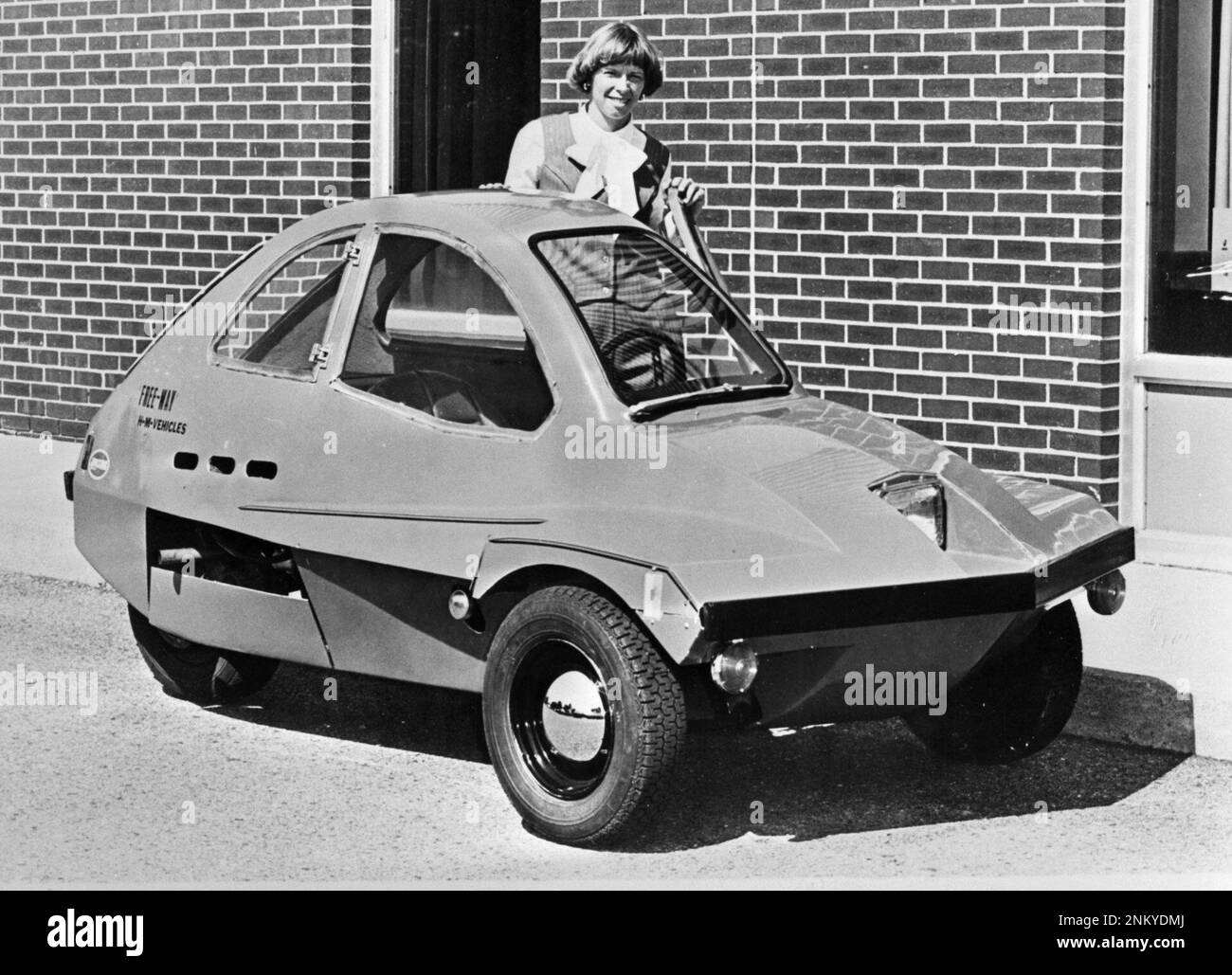 Netherlands History: Woman standing next to a three wheeler car "Free ...