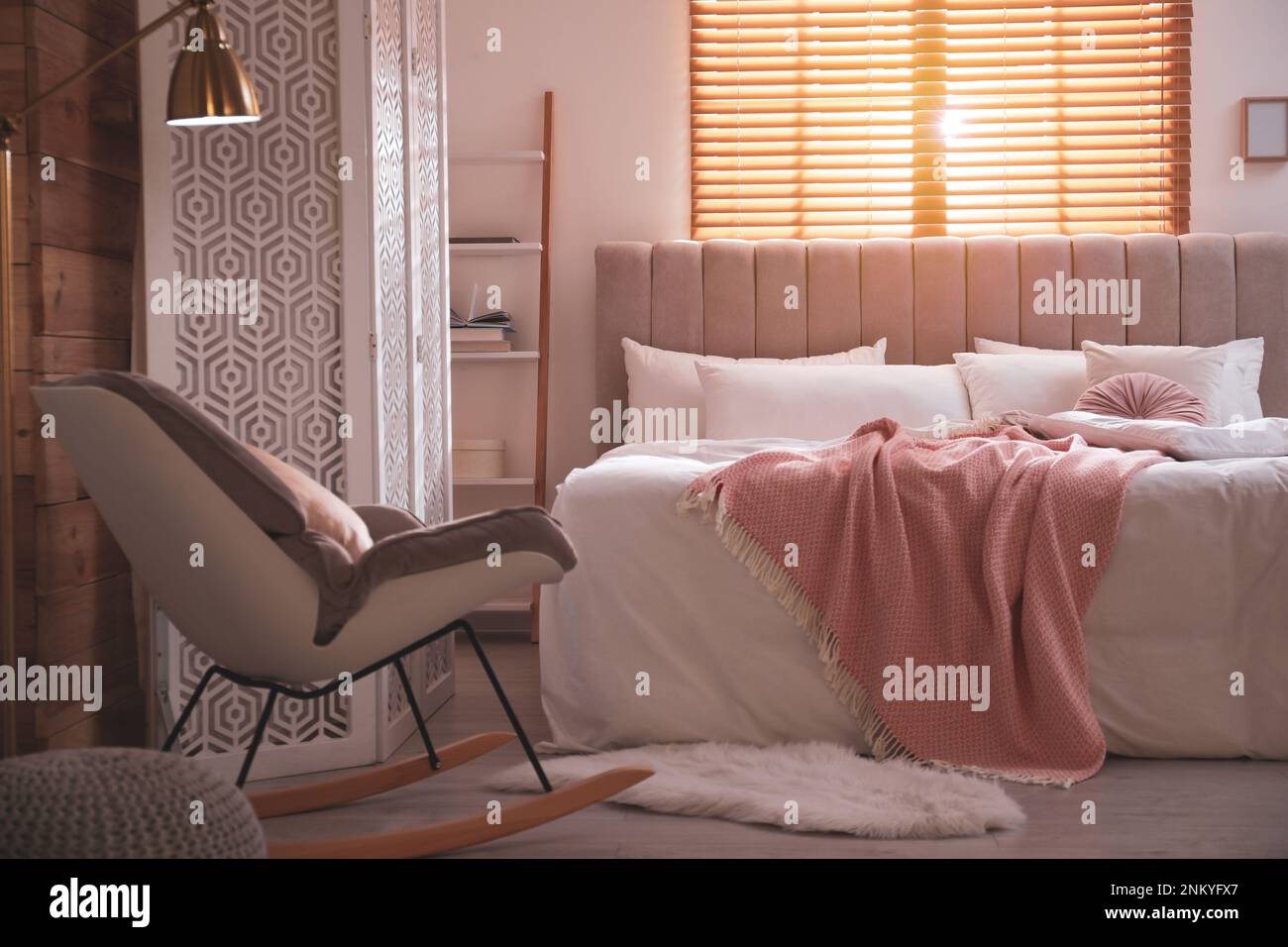 Cozy bed with soft linens in light room Stock Photo - Alamy