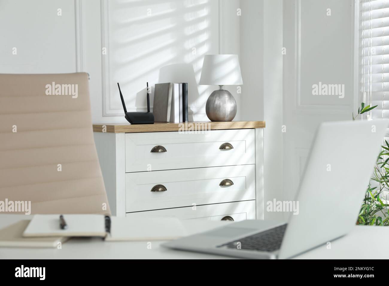 Modern wi-fi router on chest of drawers in room Stock Photo - Alamy