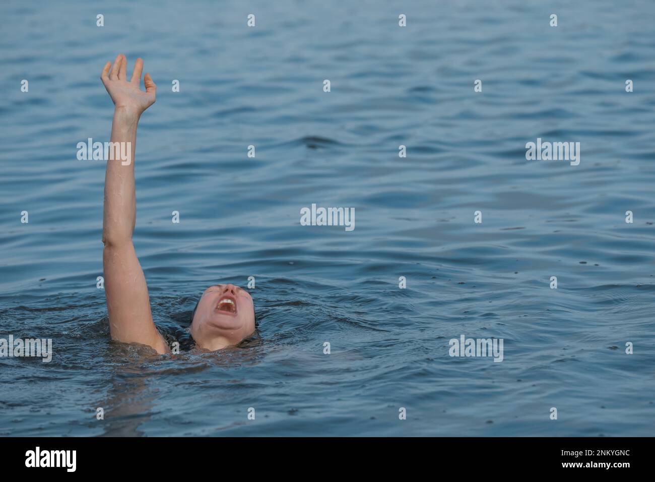 Drowning woman reaching for help in sea Stock Photo - Alamy