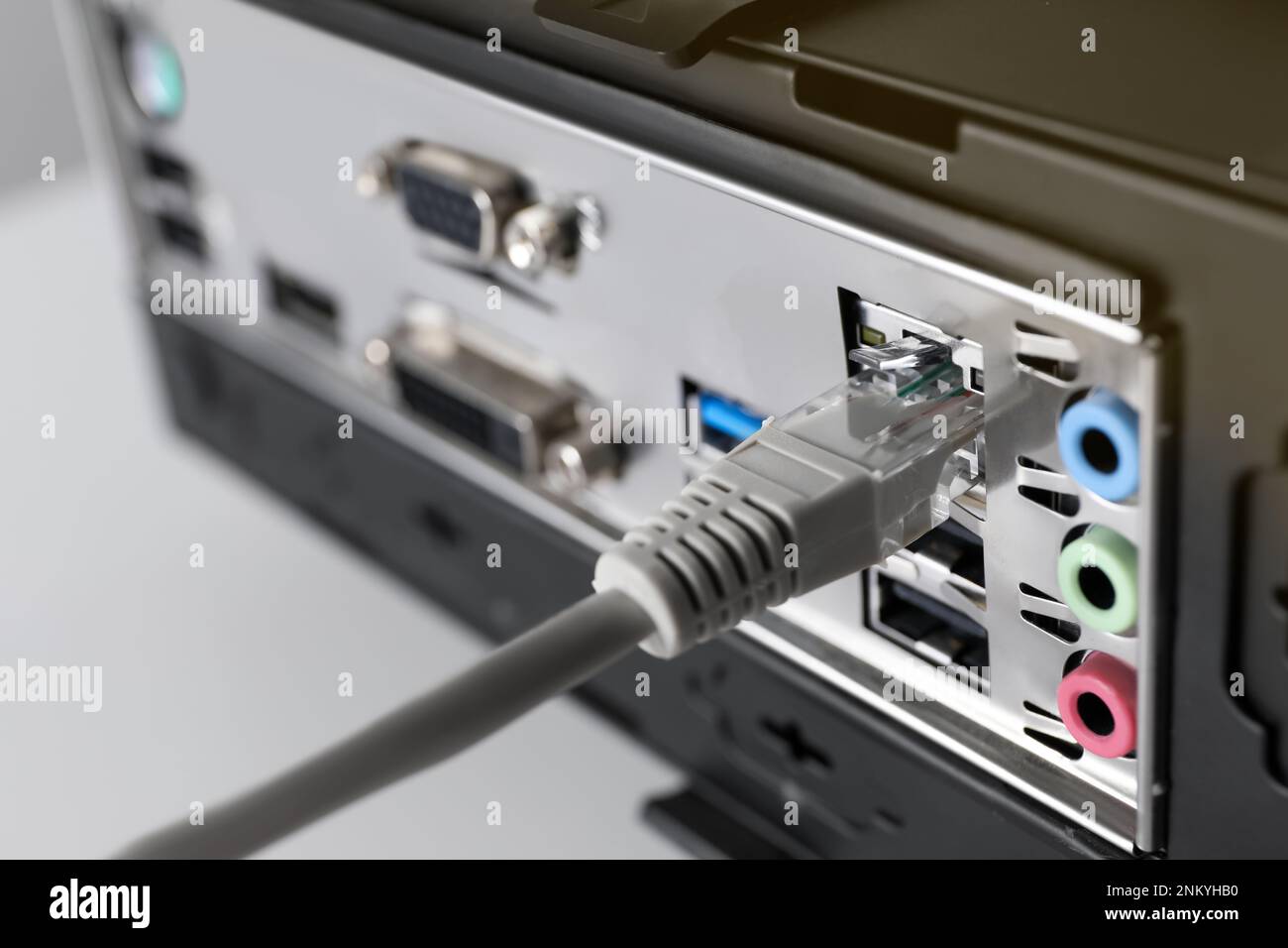 Connected cable to computer system unit on table, closeup. Internet ...