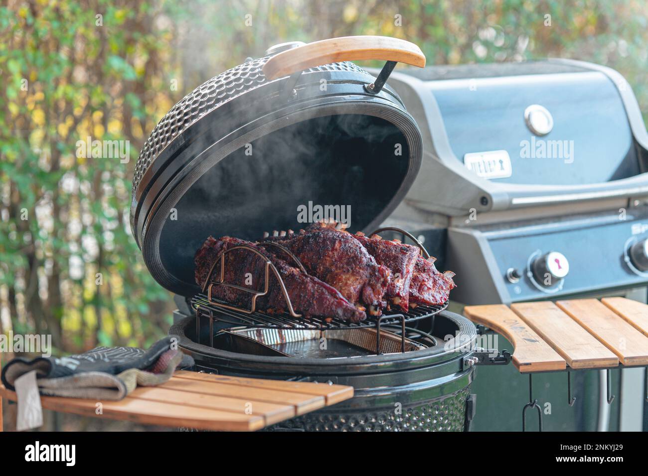 A close-up image of an outdoor grill with a variety of meats being ...