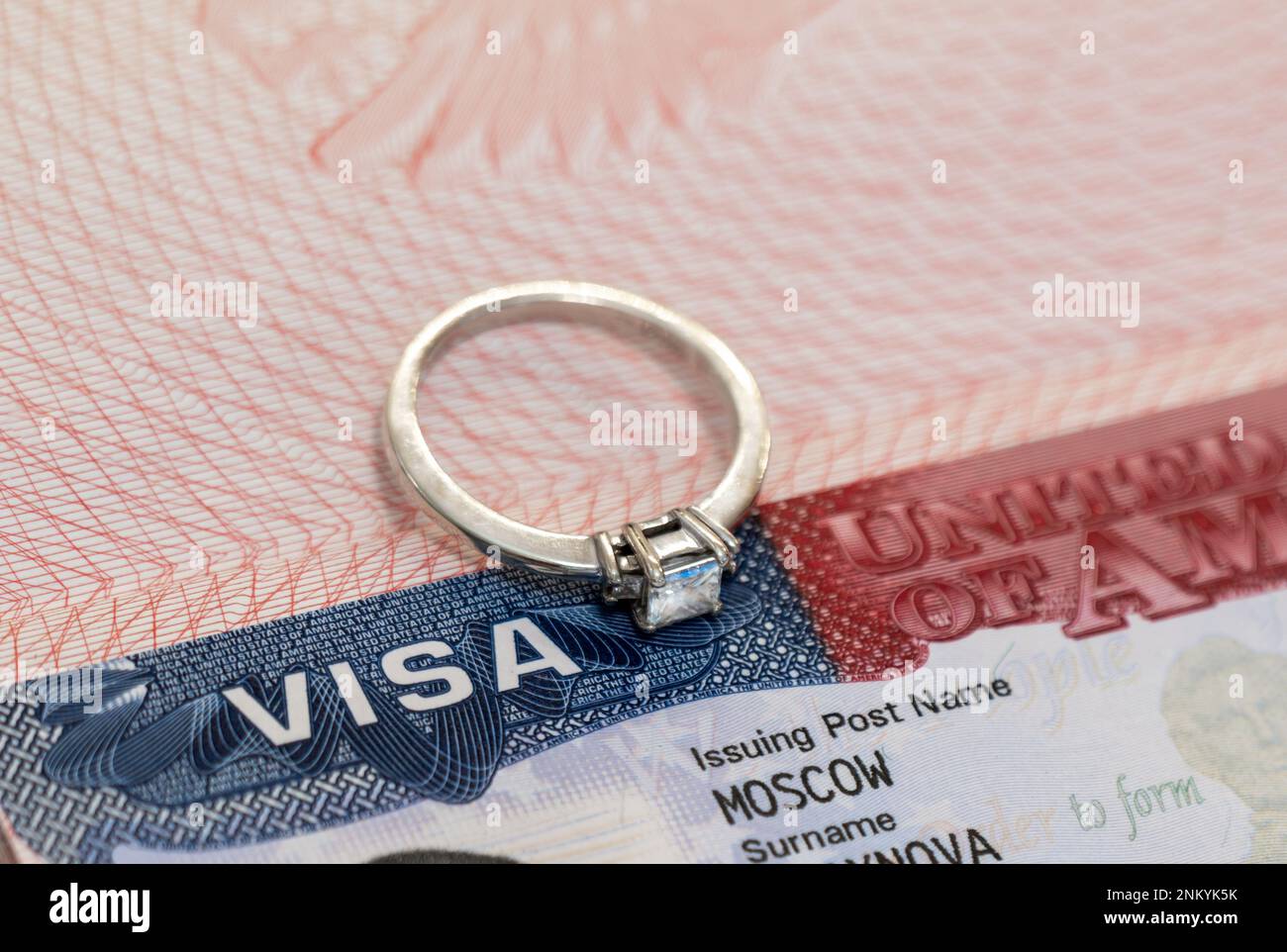 Ring with a diamond on the background of a US visa as a symbol of ...