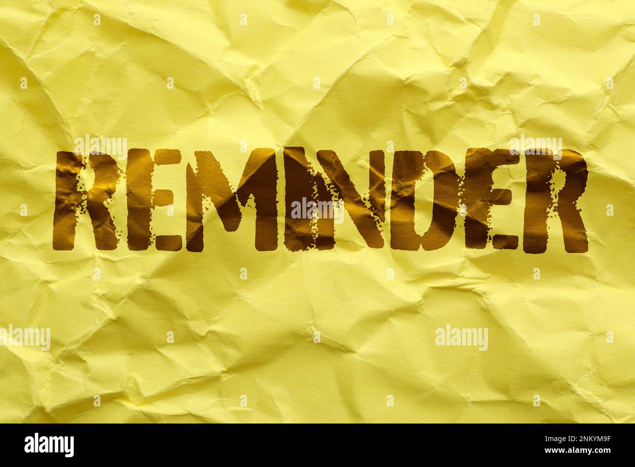 Word REMINDER written on crumpled yellow paper Stock Photo - Alamy