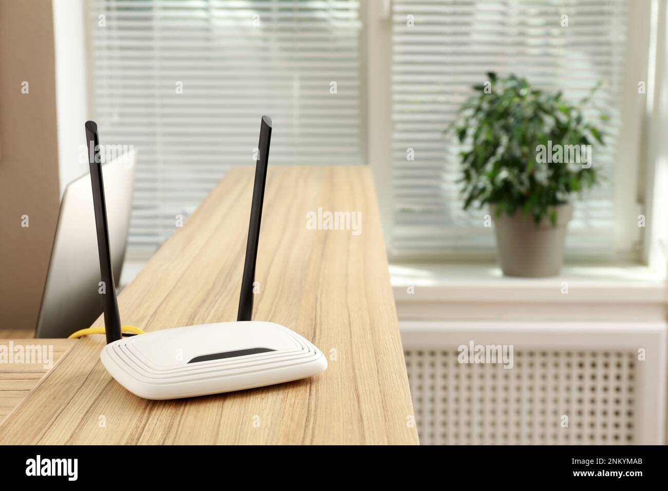 Modern wi-fi router on wooden counter indoors Stock Photo - Alamy