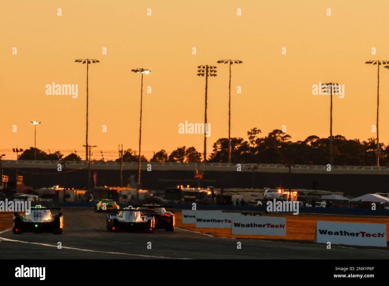 DAYTONA, FL - JANUARY 29: Cars race out of a turn during the Rolex 24 ...