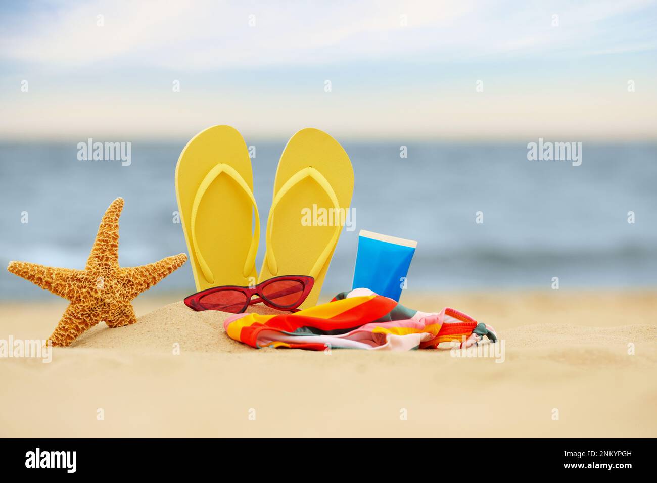 Different beach objects on sand near sea Stock Photo - Alamy