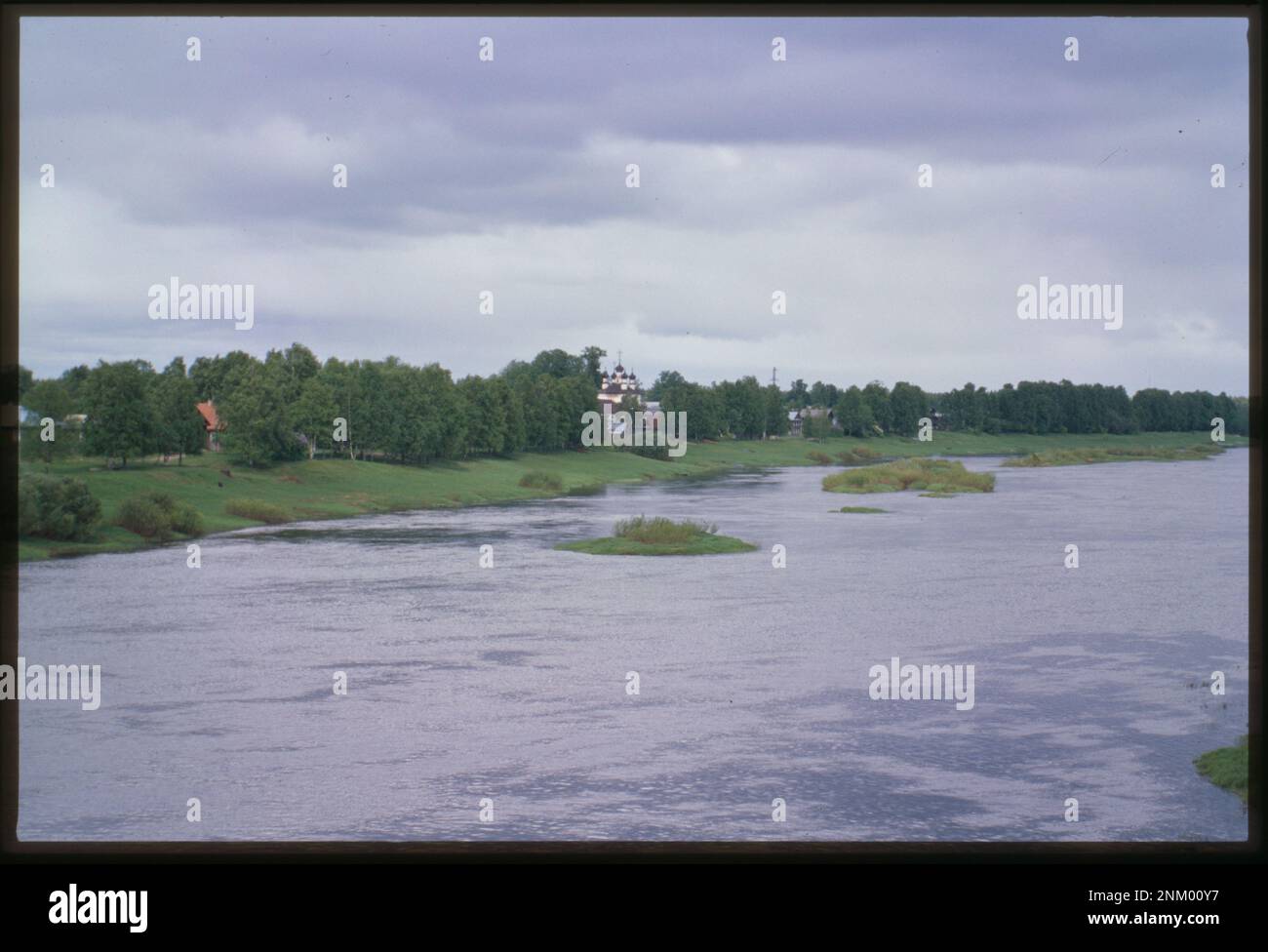 A panoramic view of the left bank of the Mologa River with the Church ...