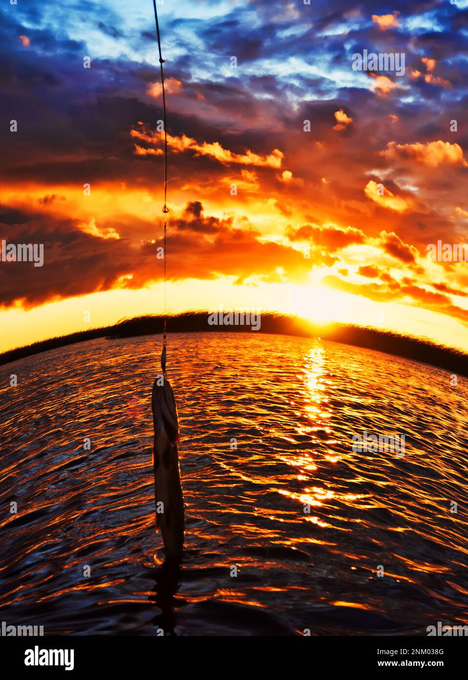 Fishing at sunset. Catching predatory fish on spinning. Sunset colors ...