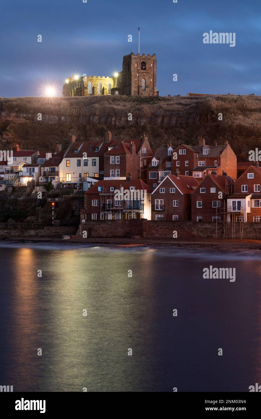 Dusk falls over Whitby harbour and the Church of St. Mary, North ...