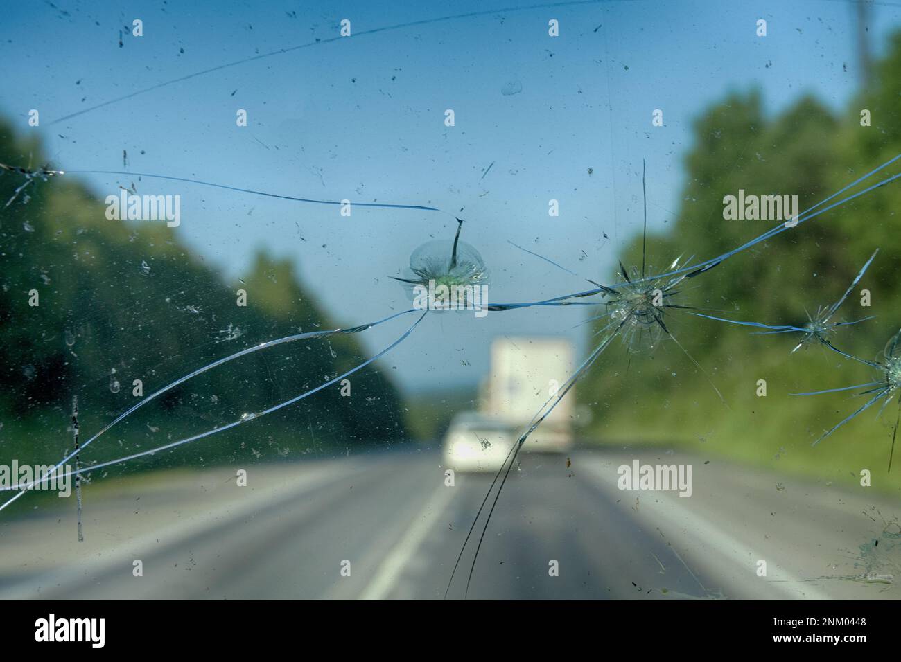 Highway through a broken windshield after encountering a truck with ...