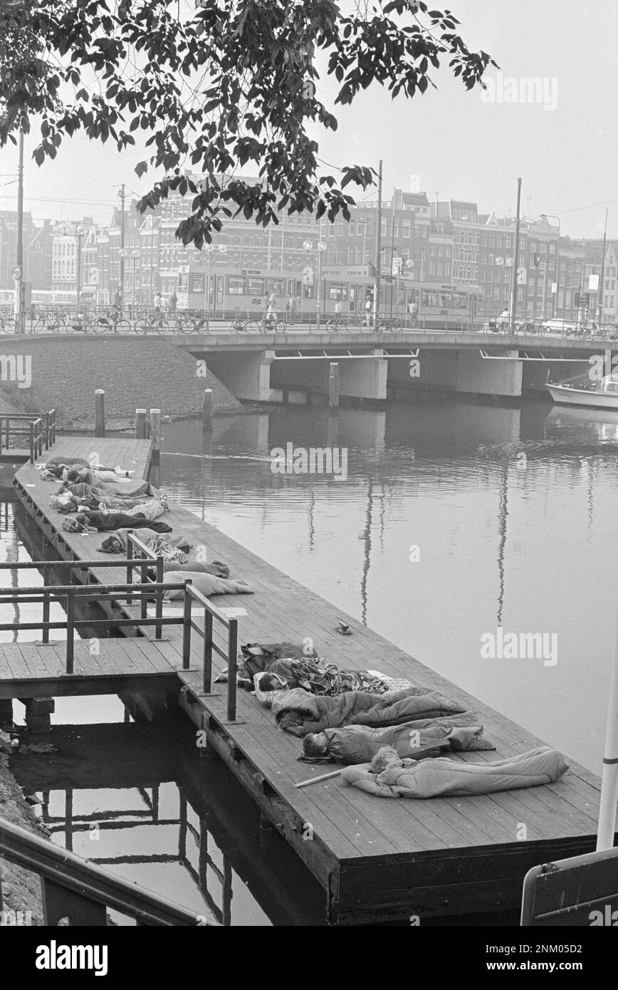 Sleeping tourists on the jetty in front of the central station in ...