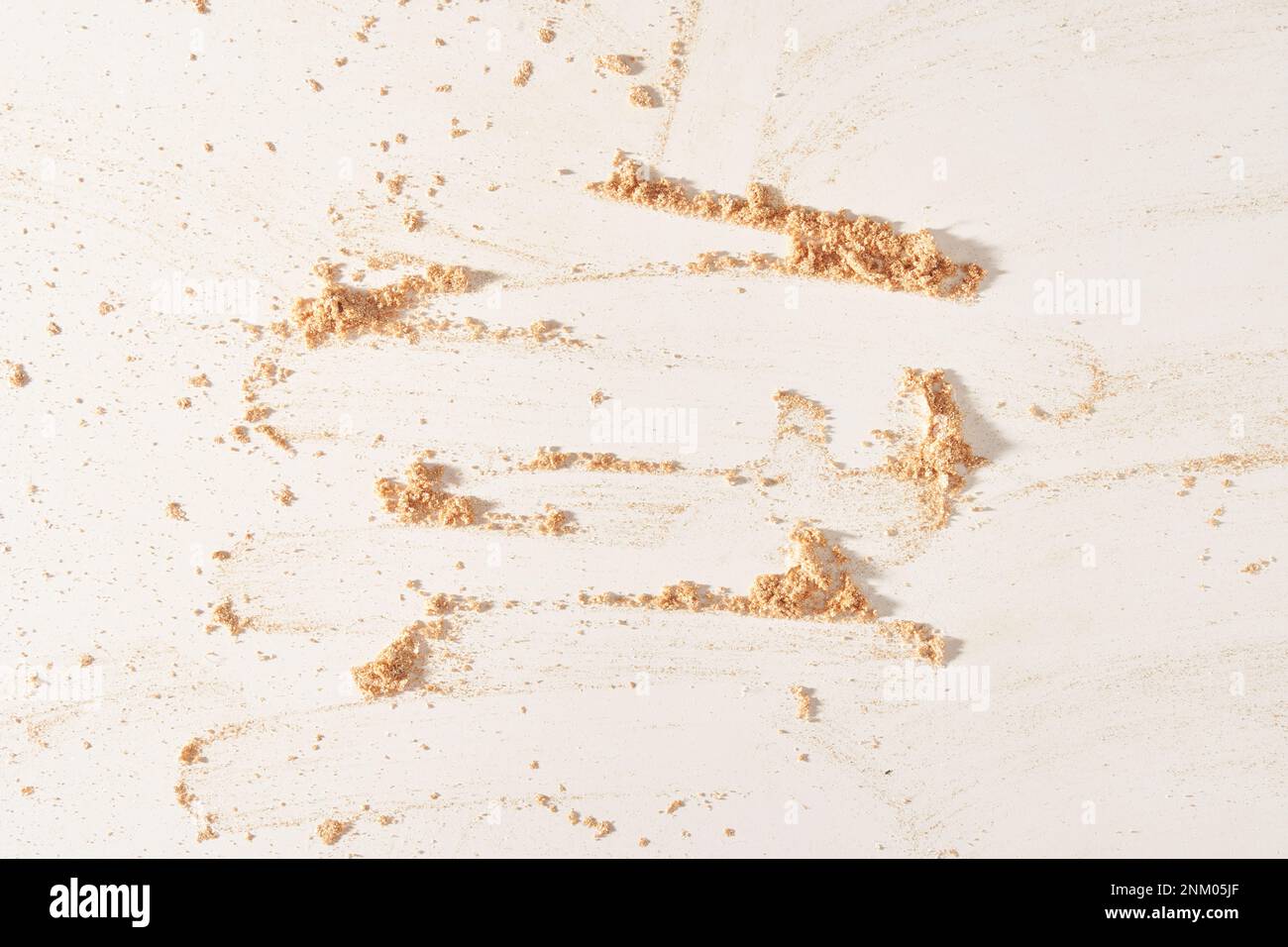 A neutral-colored face powder smeared on the surface, on a light ...