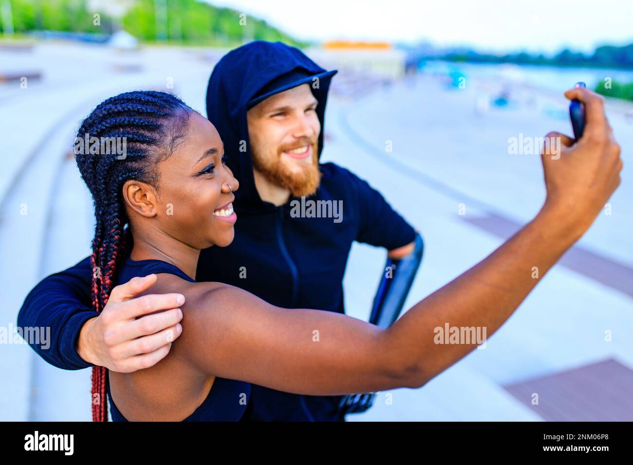 mixer-race couple in love embrace in each other's arms outdoors Stock ...