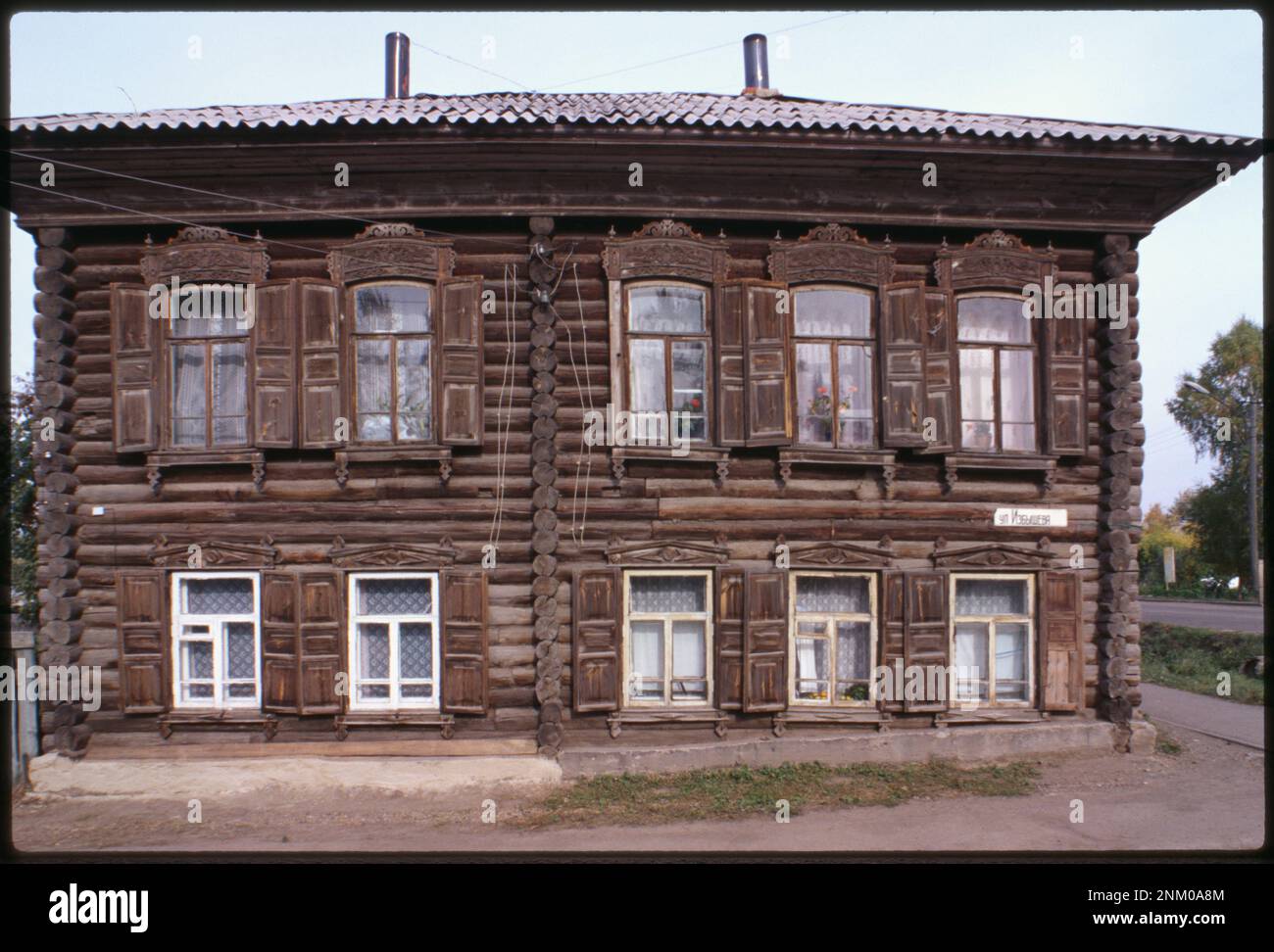 A late 19th-century log house on Izbyshev Street in Tara, Russia. This ...
