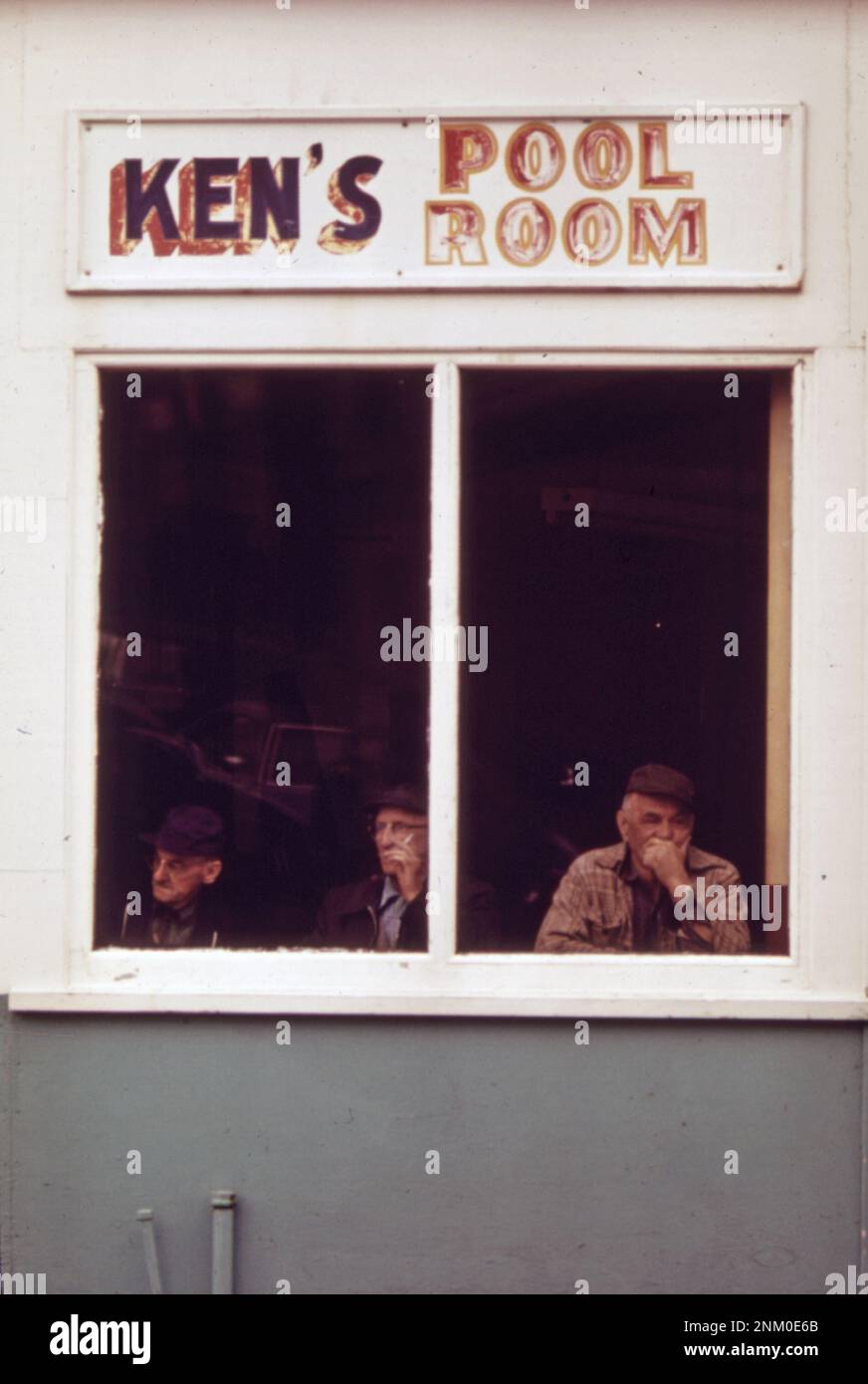 1970s United States: Men looking out window at Main Street from Ken's ...