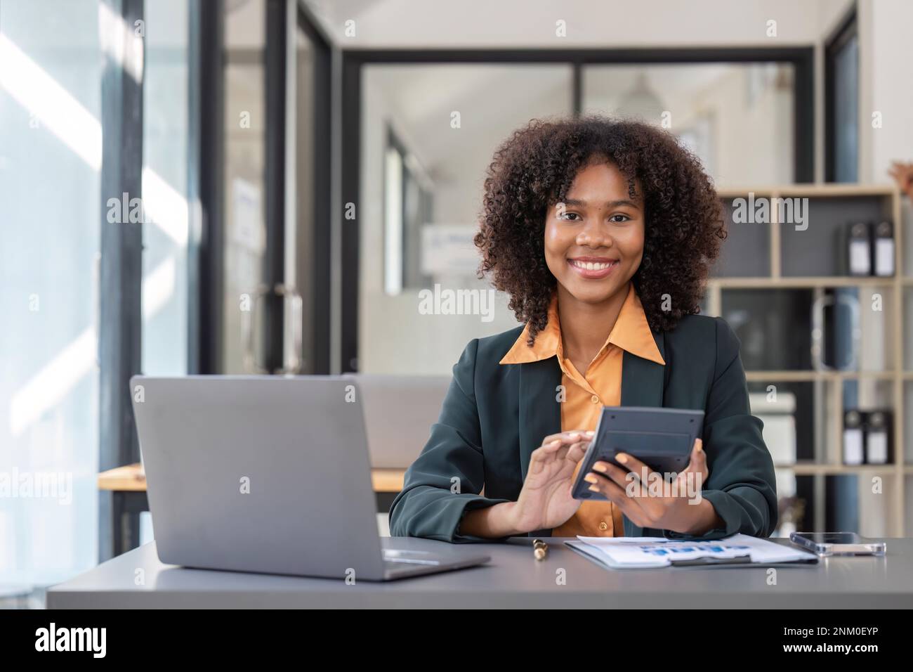 Accountant black woman working on laptop and do document, tax, exchange ...