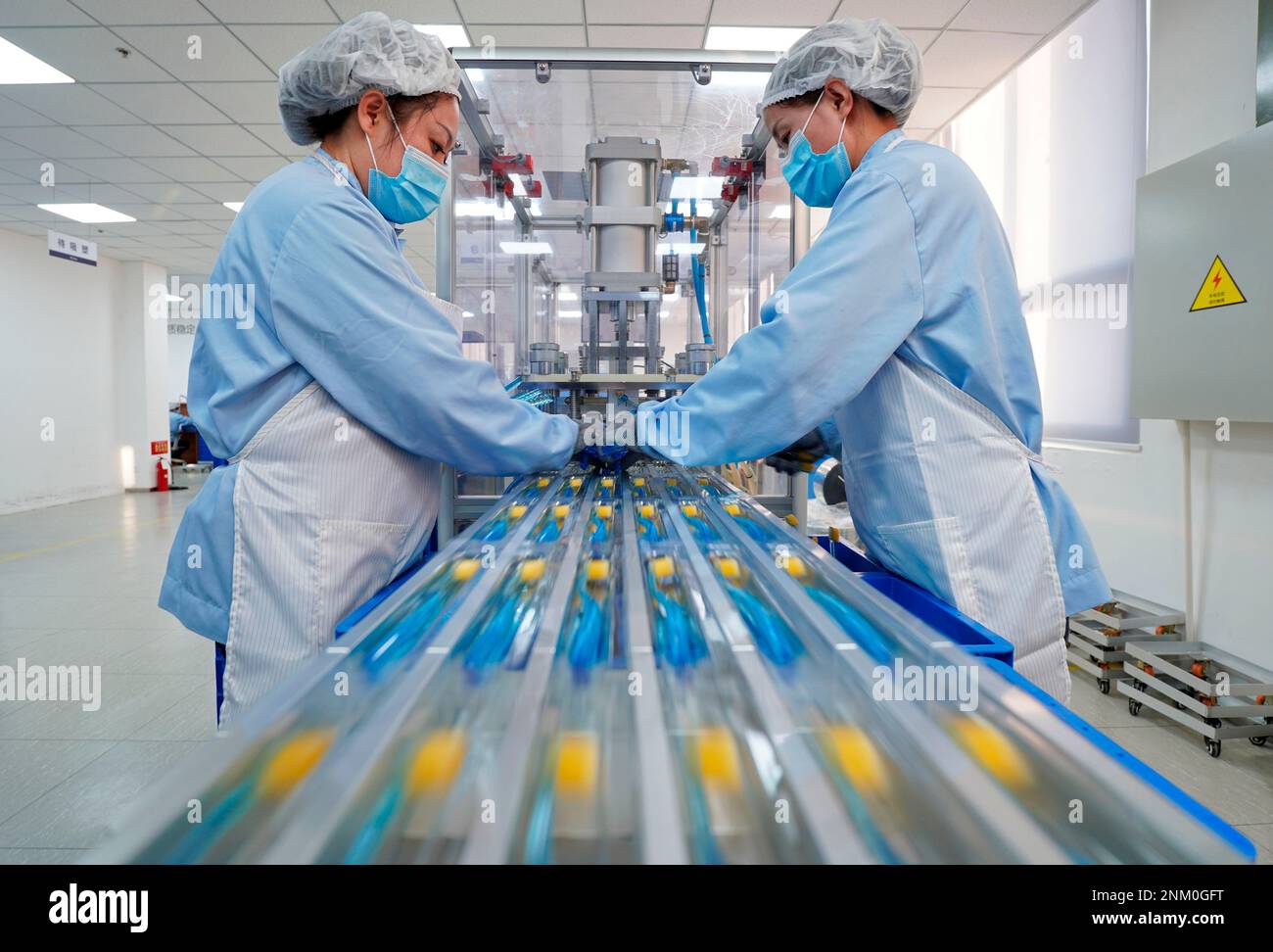 Women work on the production line of toothbrushes at a factory in ...