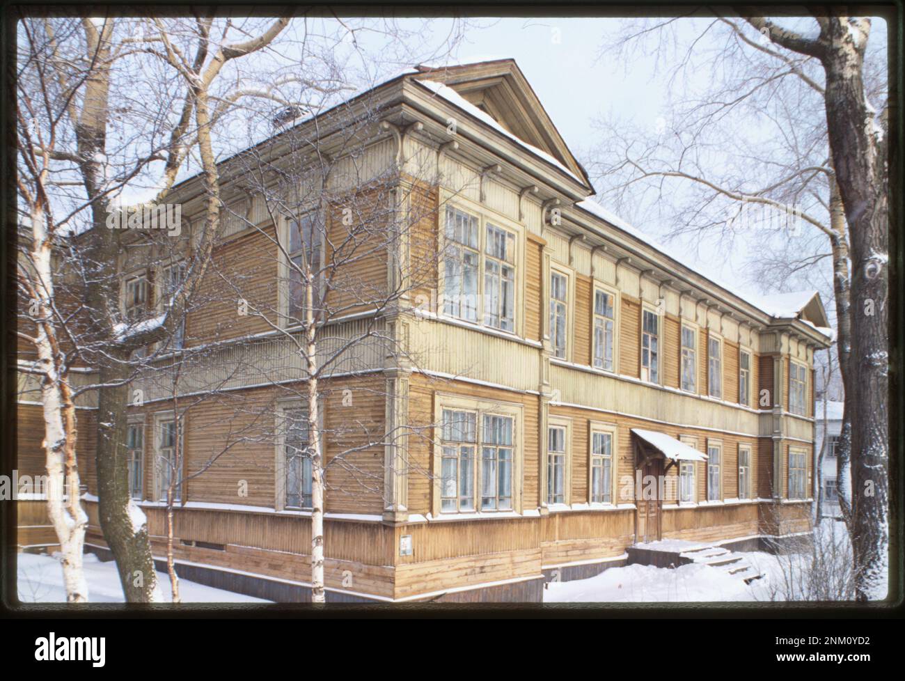 A wooden log apartment house situated on the Dvina River embankment in ...