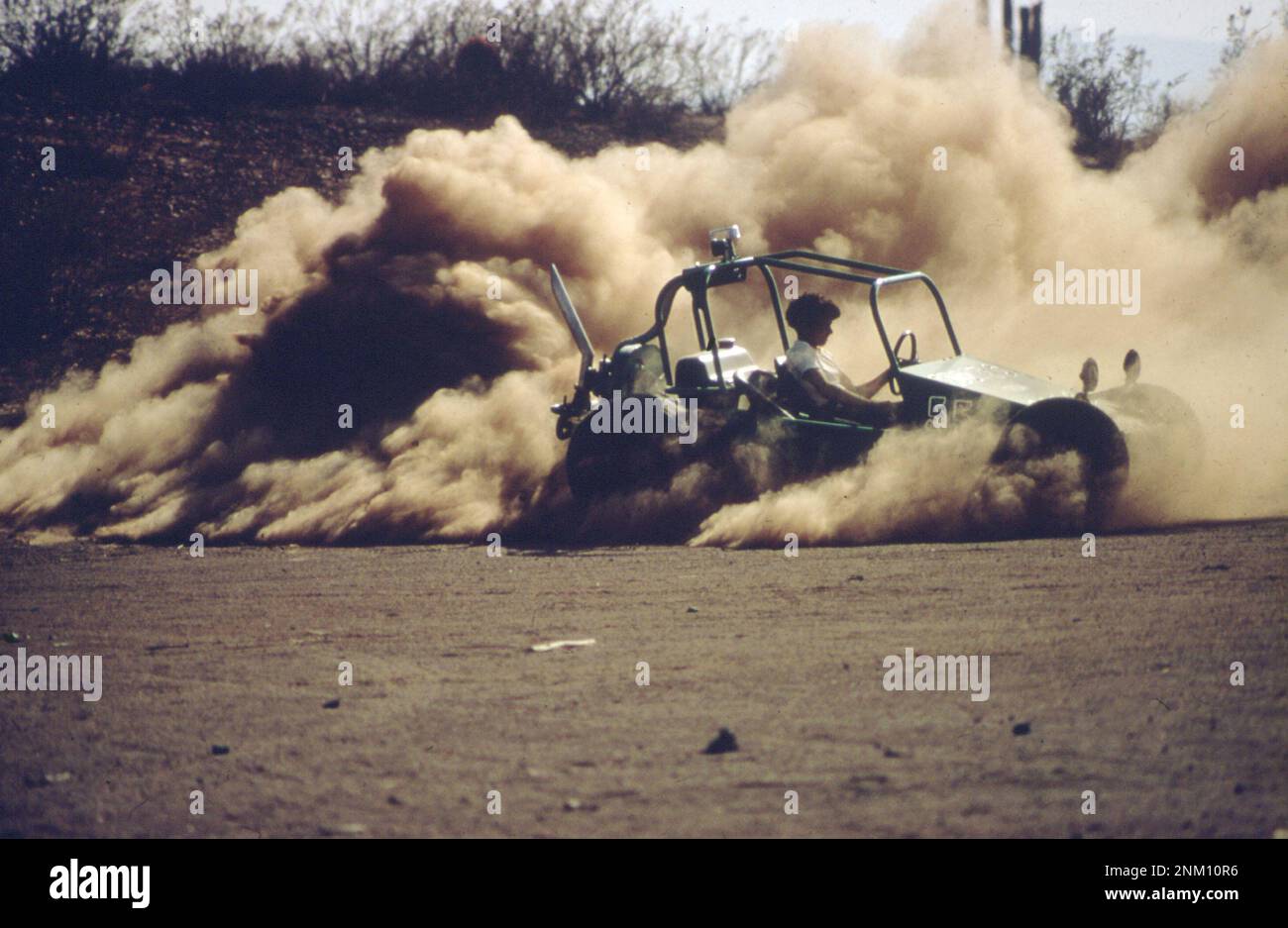 1970s America: Sand vehicle (dune buggy) scarring desert terrain of ...