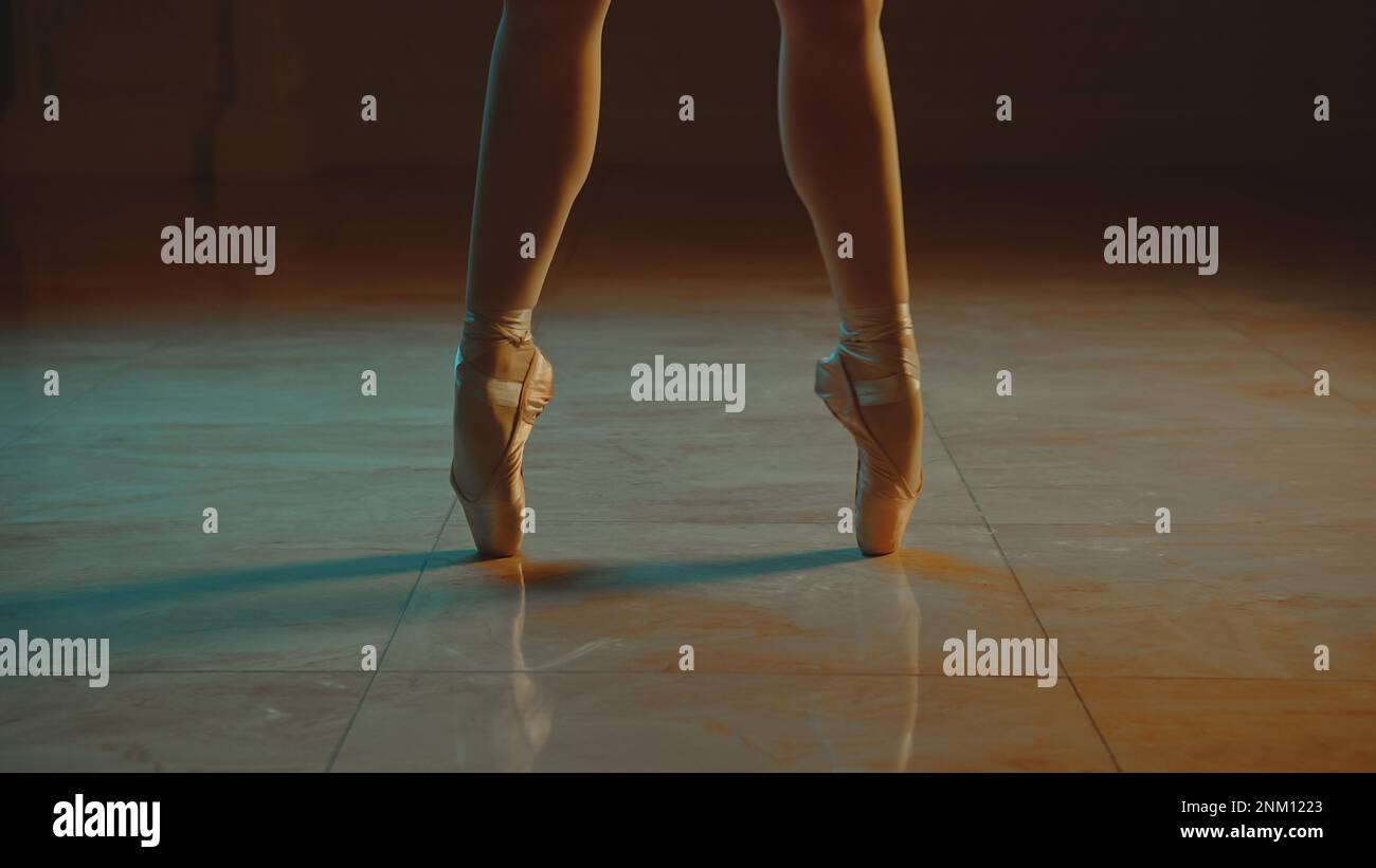 Cinematic close up shot of graceful ballet dancer feet in pointe shoes ...
