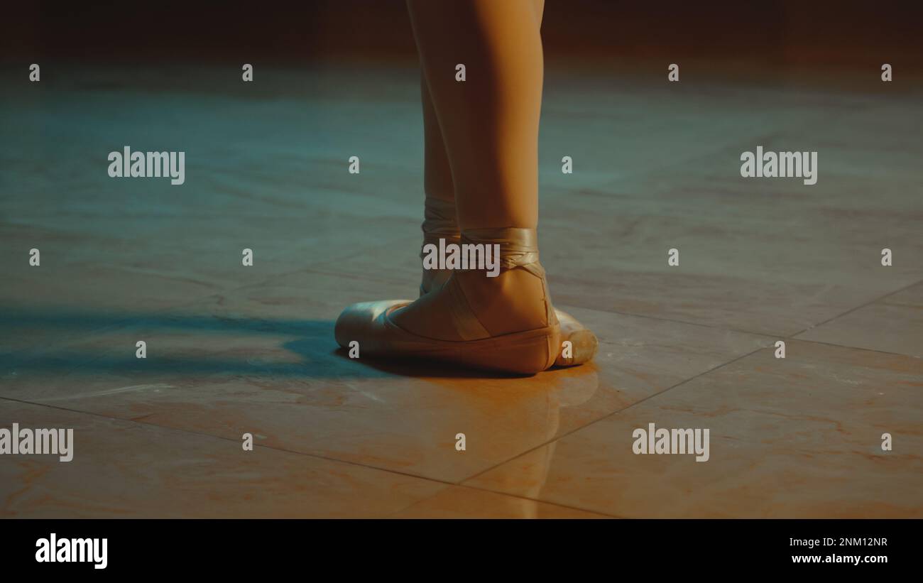 Cinematic close up shot of classical ballet dancer feet in pointe shoes ...