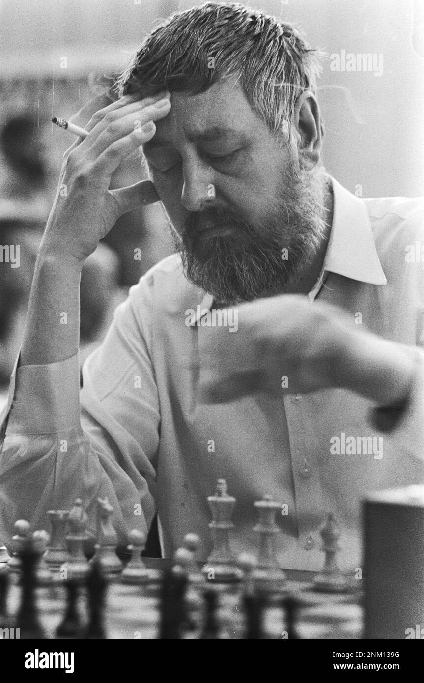 IBM chess tournament - Jan Hein Donner making a move while holding a ...