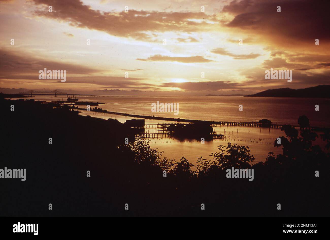 1970s United States: Sunset at the river mouth of the Columbia River ...