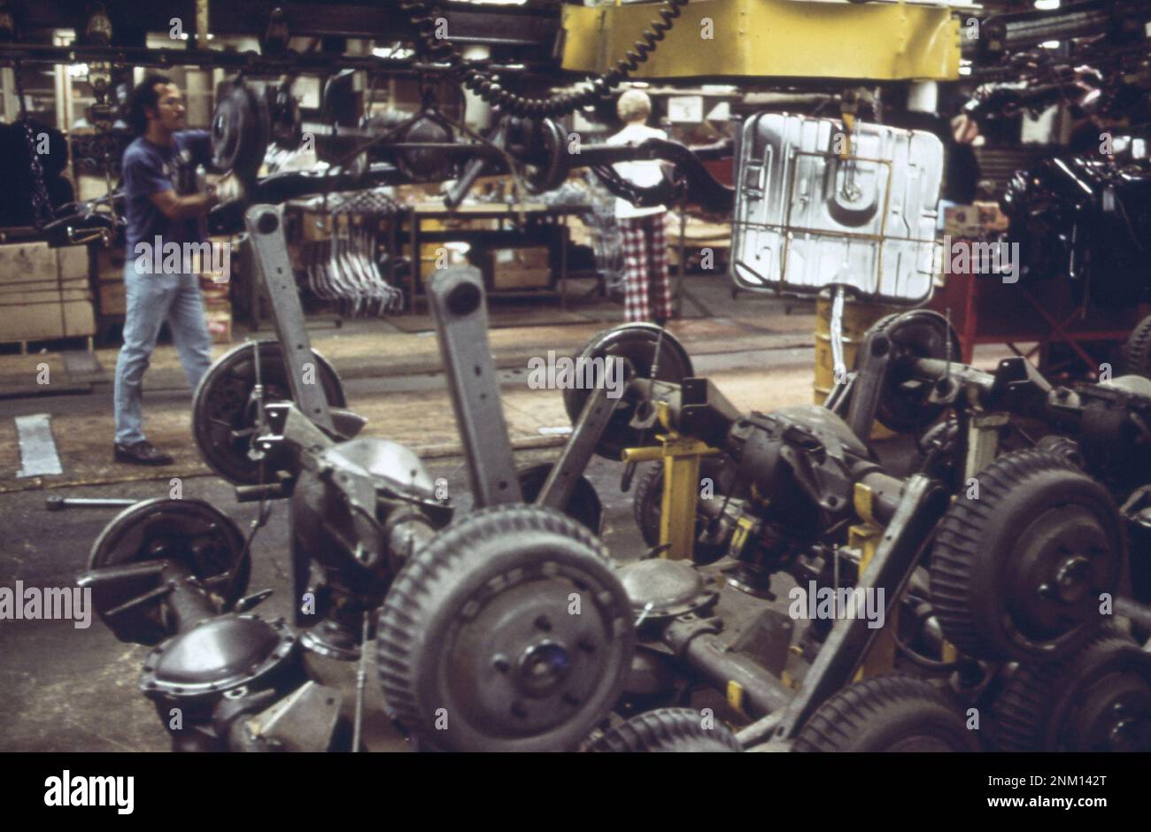 1970s America: On the Cadillac assembly line--axles ready to be matched ...