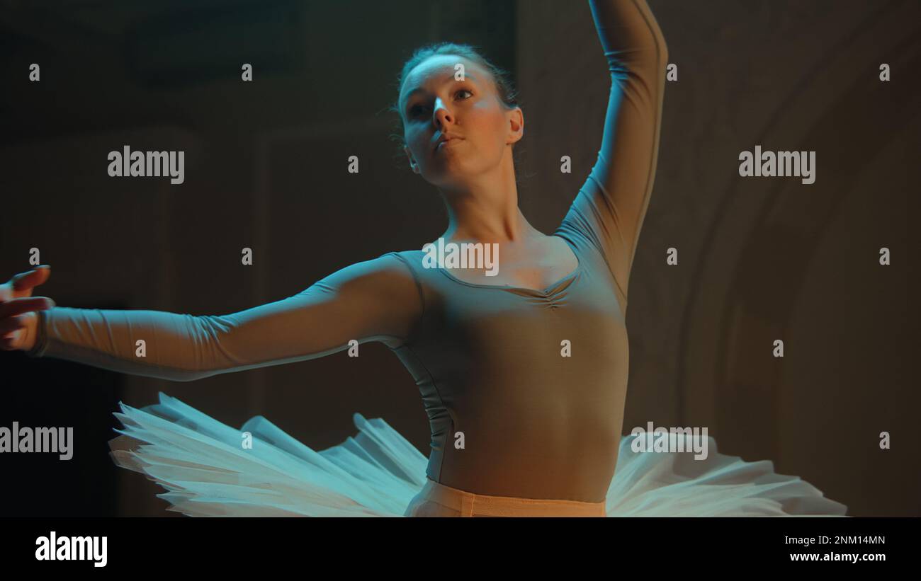 Cinematic shot of beautiful classical ballet female dancer in white ...