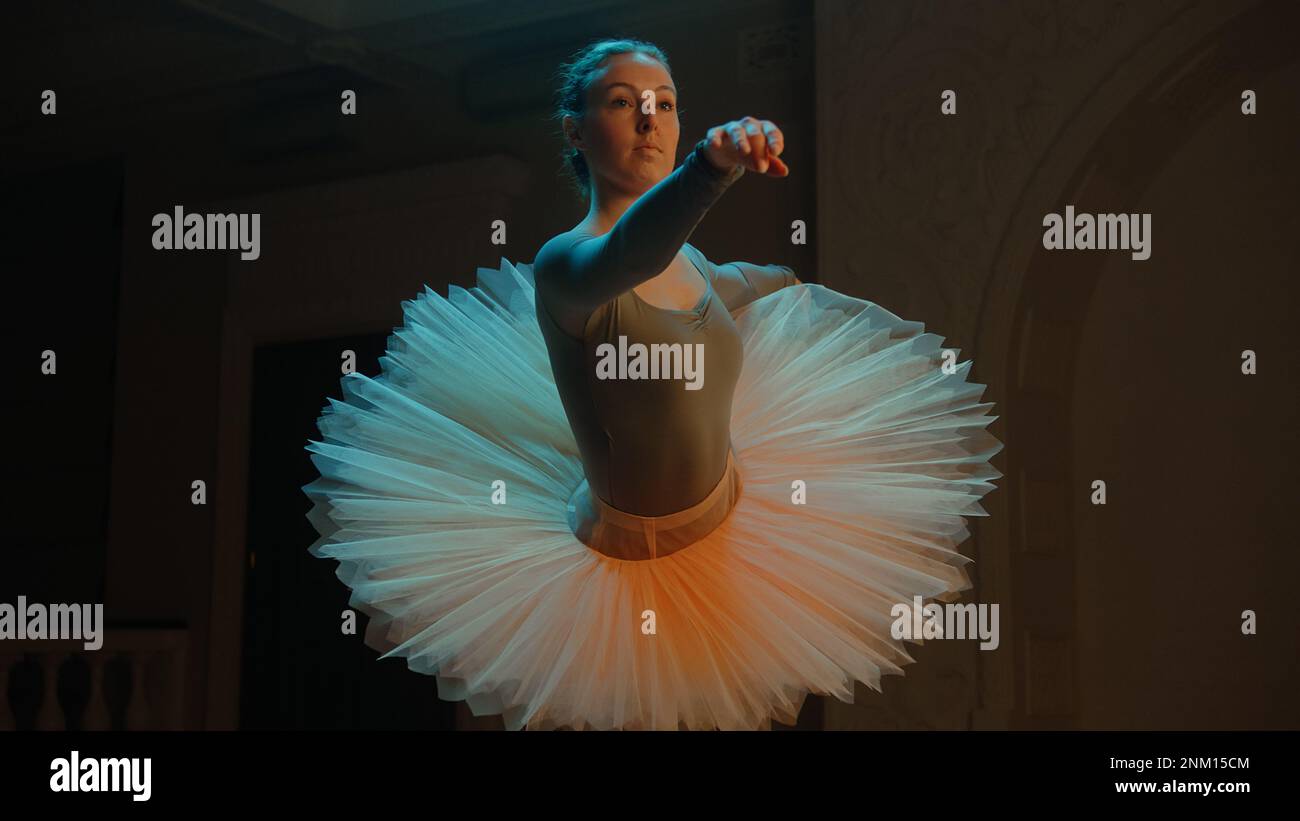 Cinematic shot of beautiful classical ballet female dancer in white ...