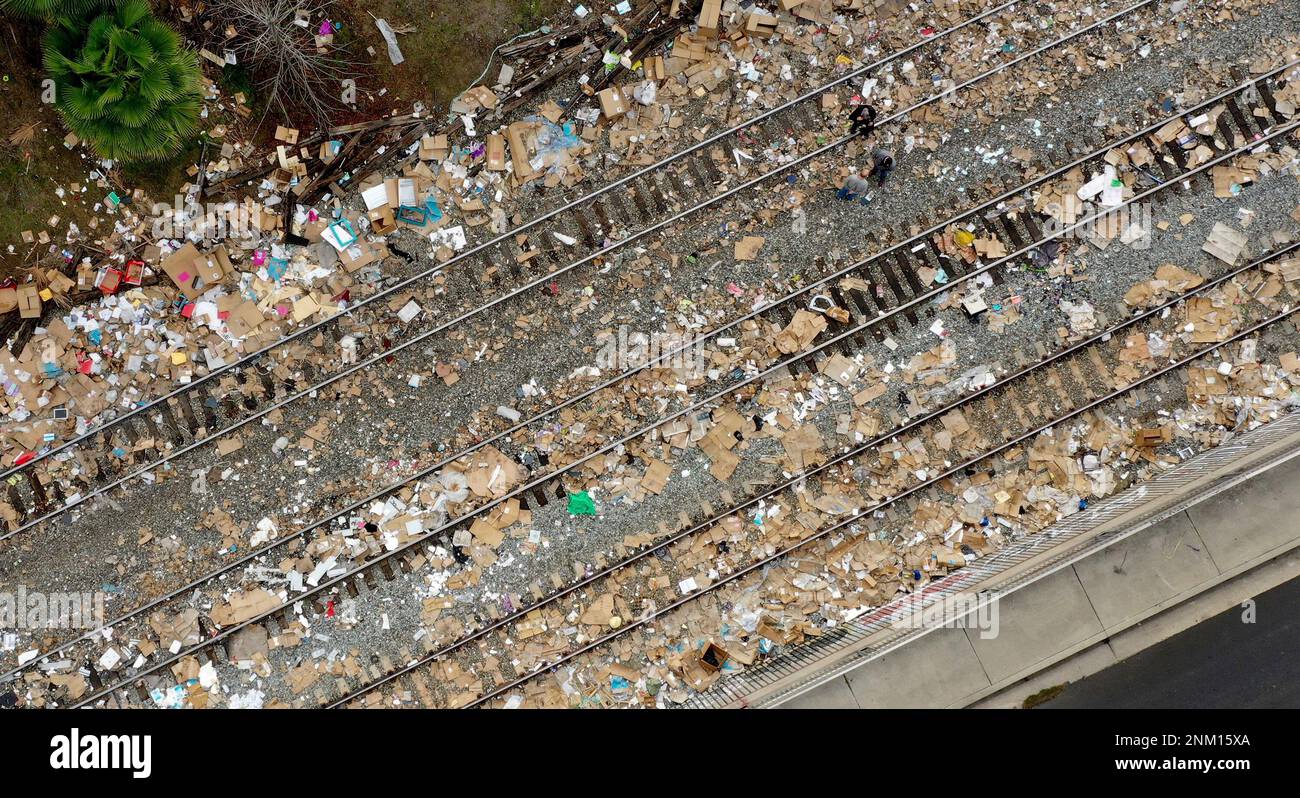 Shredded boxes and packages and debris are strewn along at a section of ...
