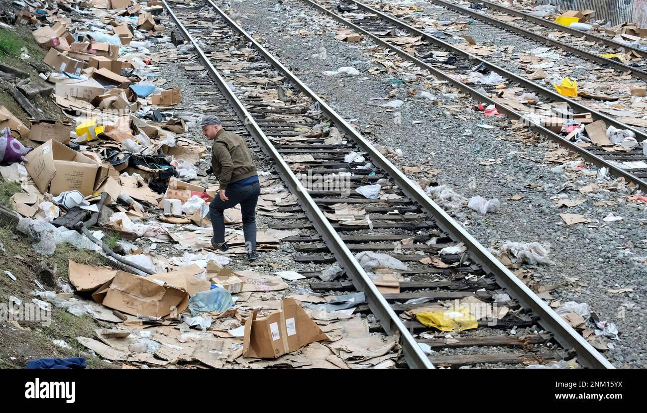 Shredded boxes and packages and debris are strewn along at a section of ...